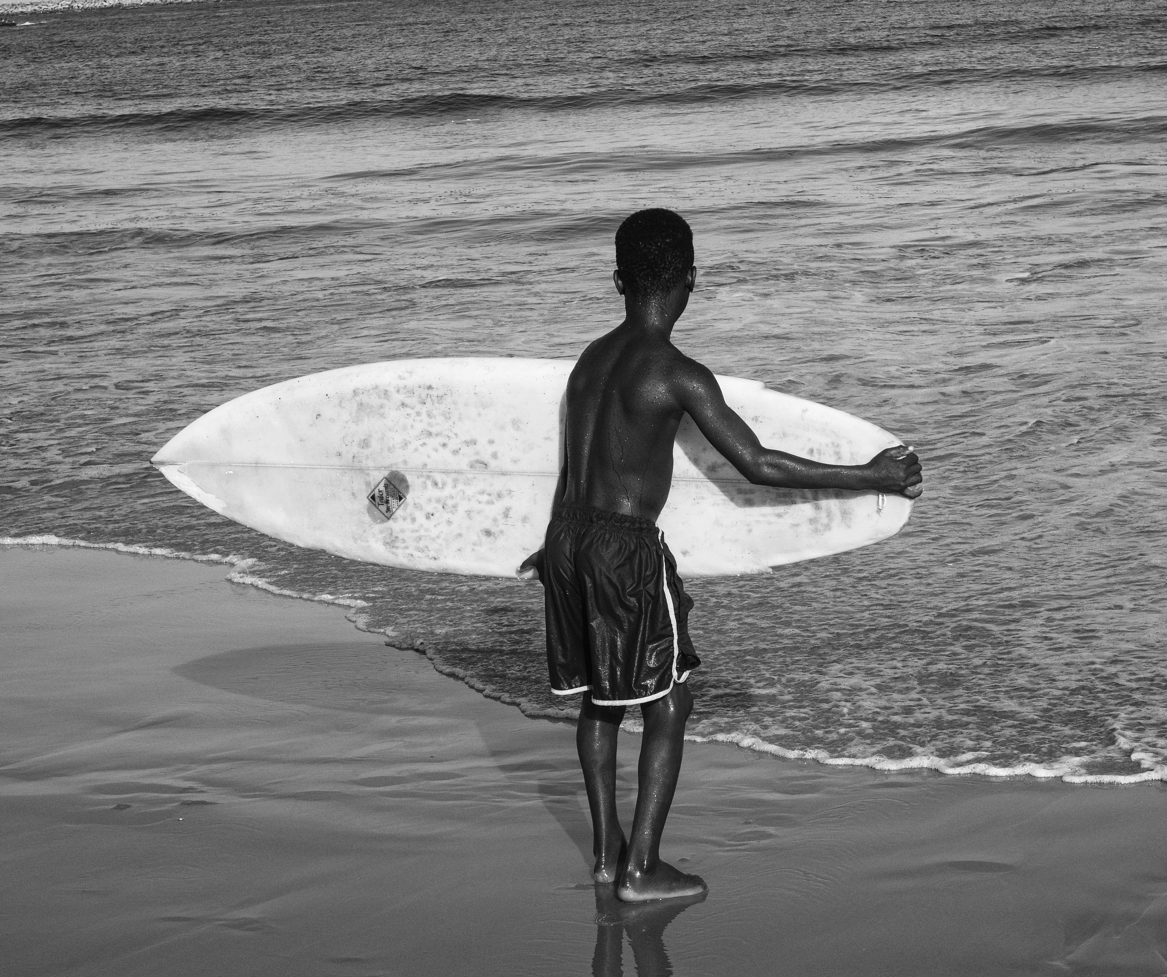 Surfboarder’s Quiet Moment: A Shadowy Silhouette at the Shore
