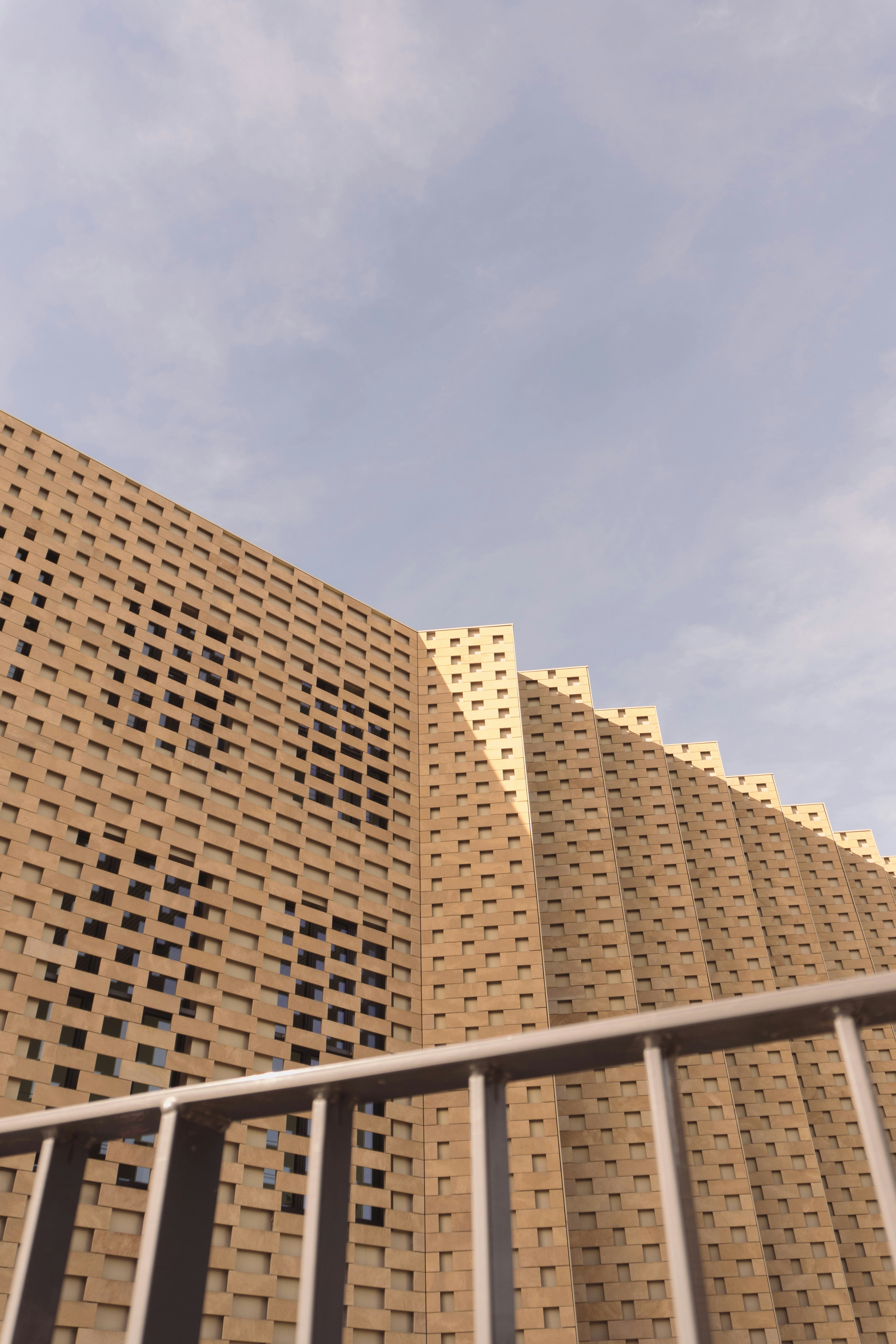 Urban Facade Echoes: Geometric Light on Recessed Brickwork