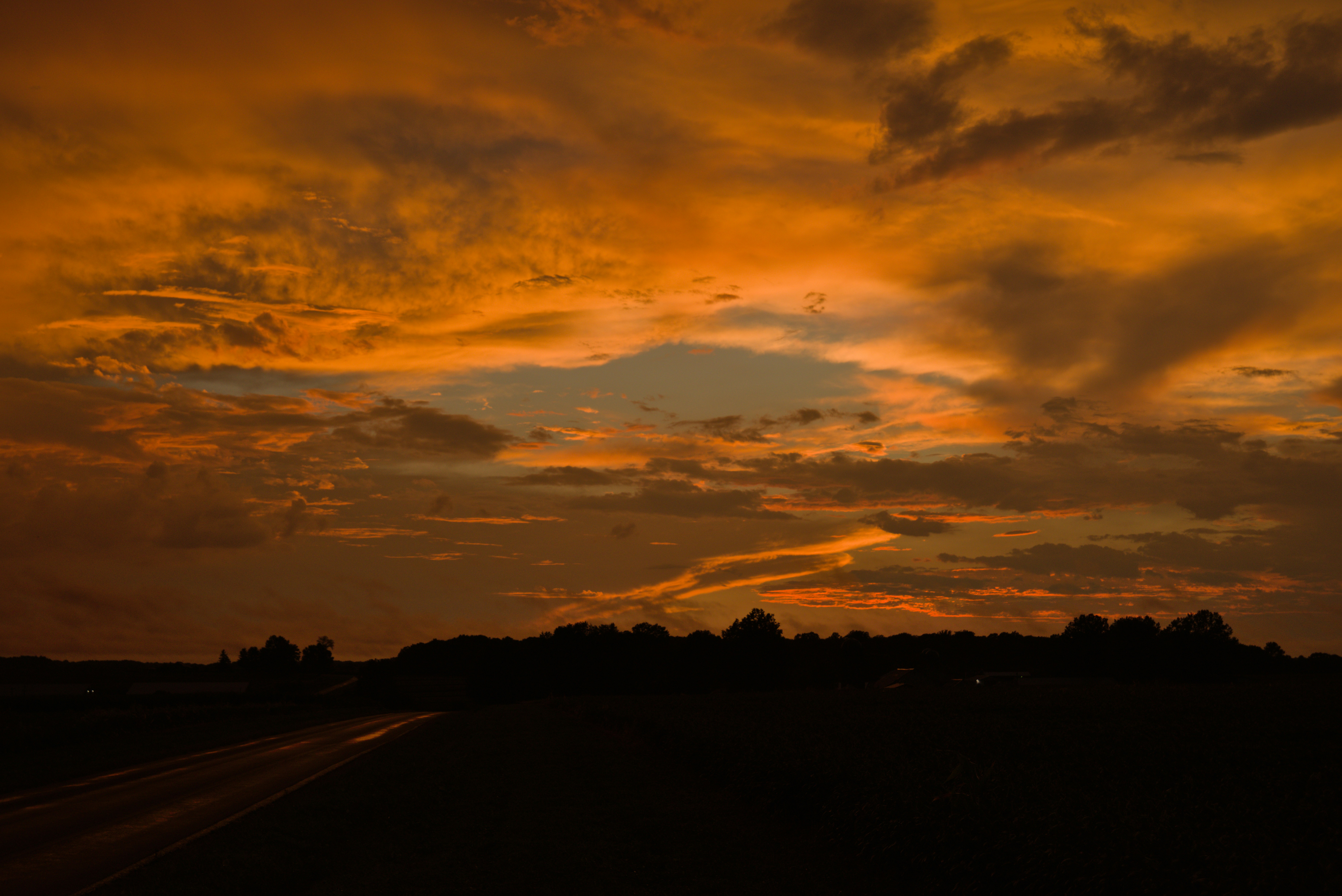 Ember-skied Horizon: A Quiet Road Beneath a Fiery Evening