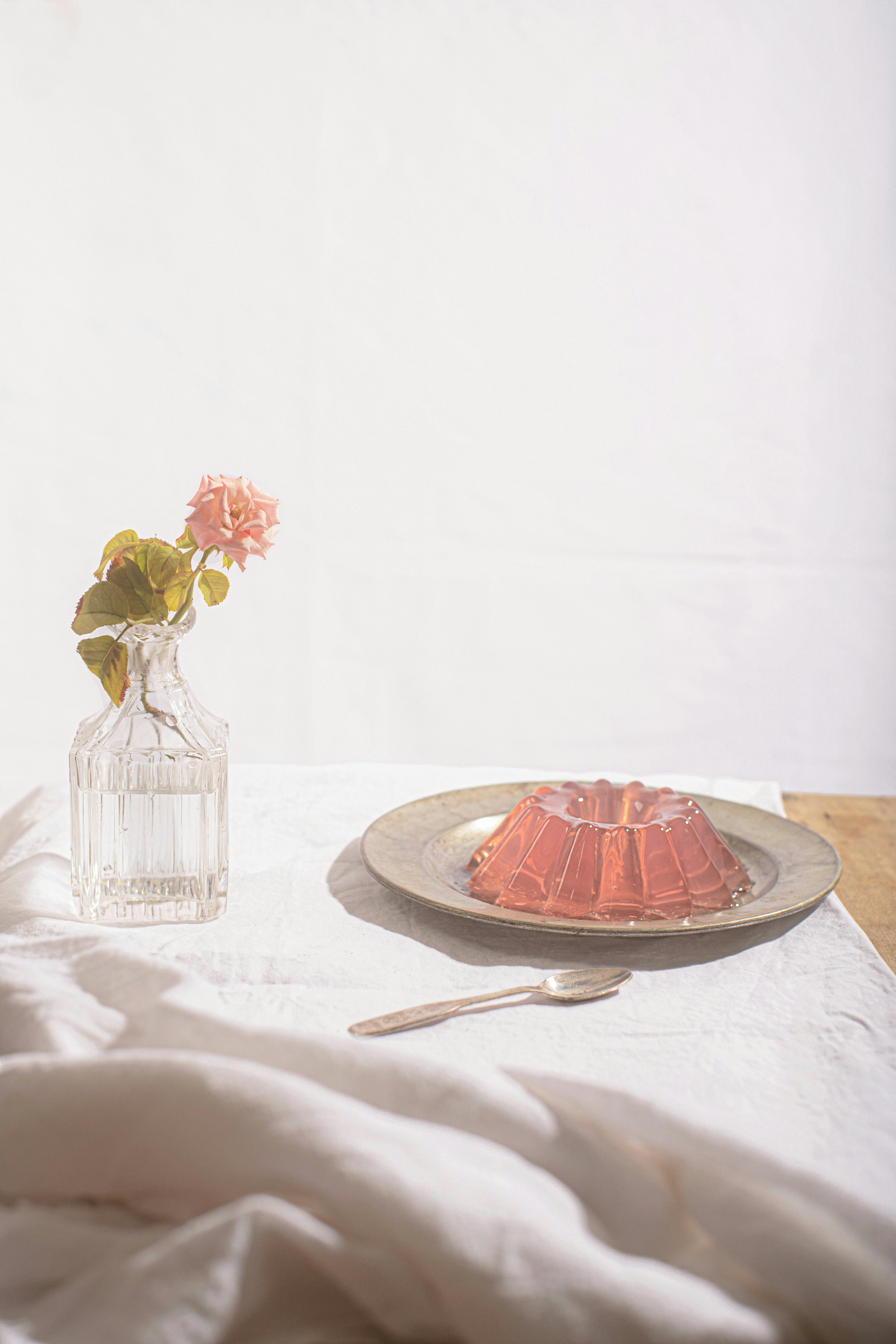Gentle Light on a Quiet Table: Rose in Glass and Pink Pudding
