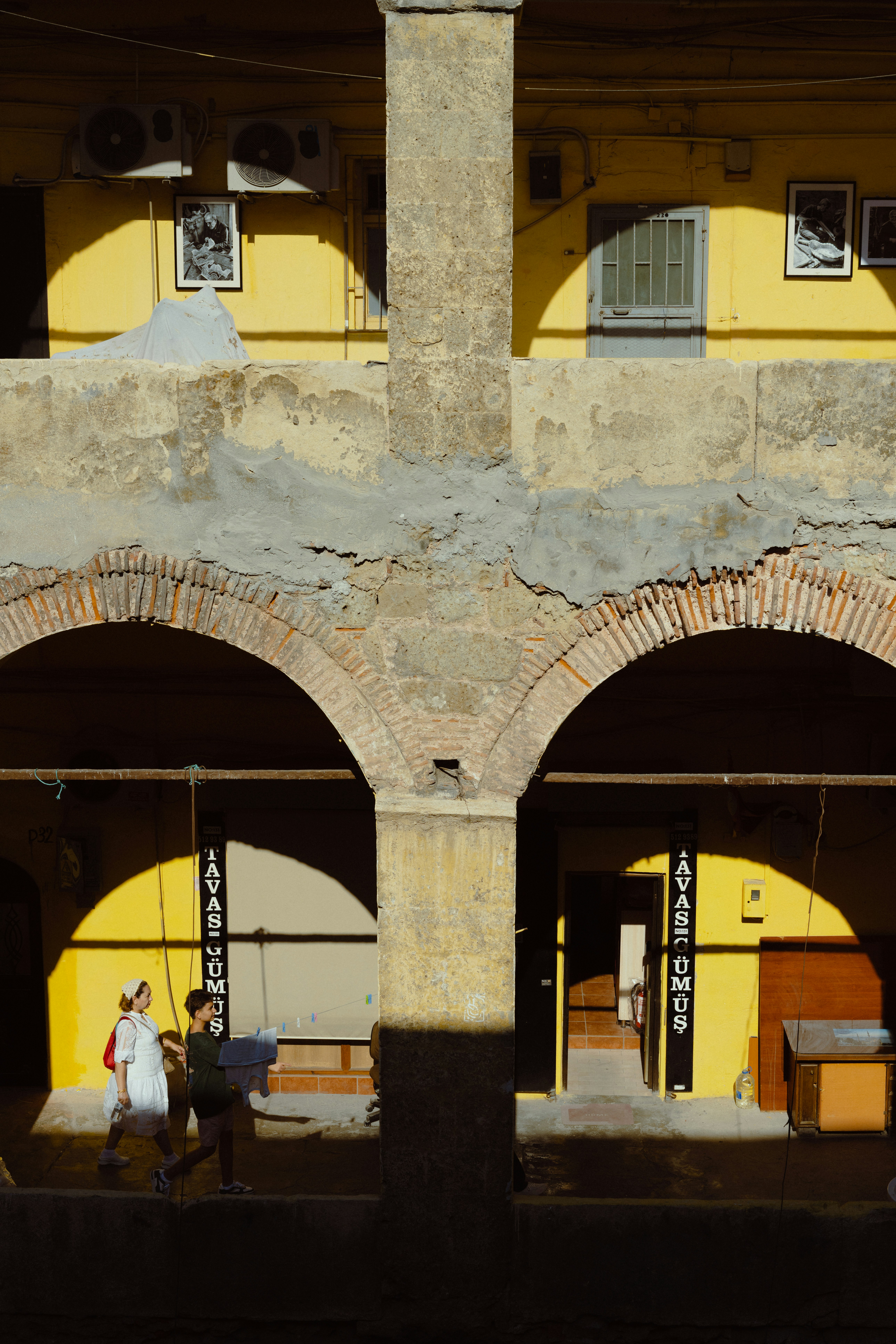 Sunlit Arcades: A Quiet Moment Under the Stone Pillar