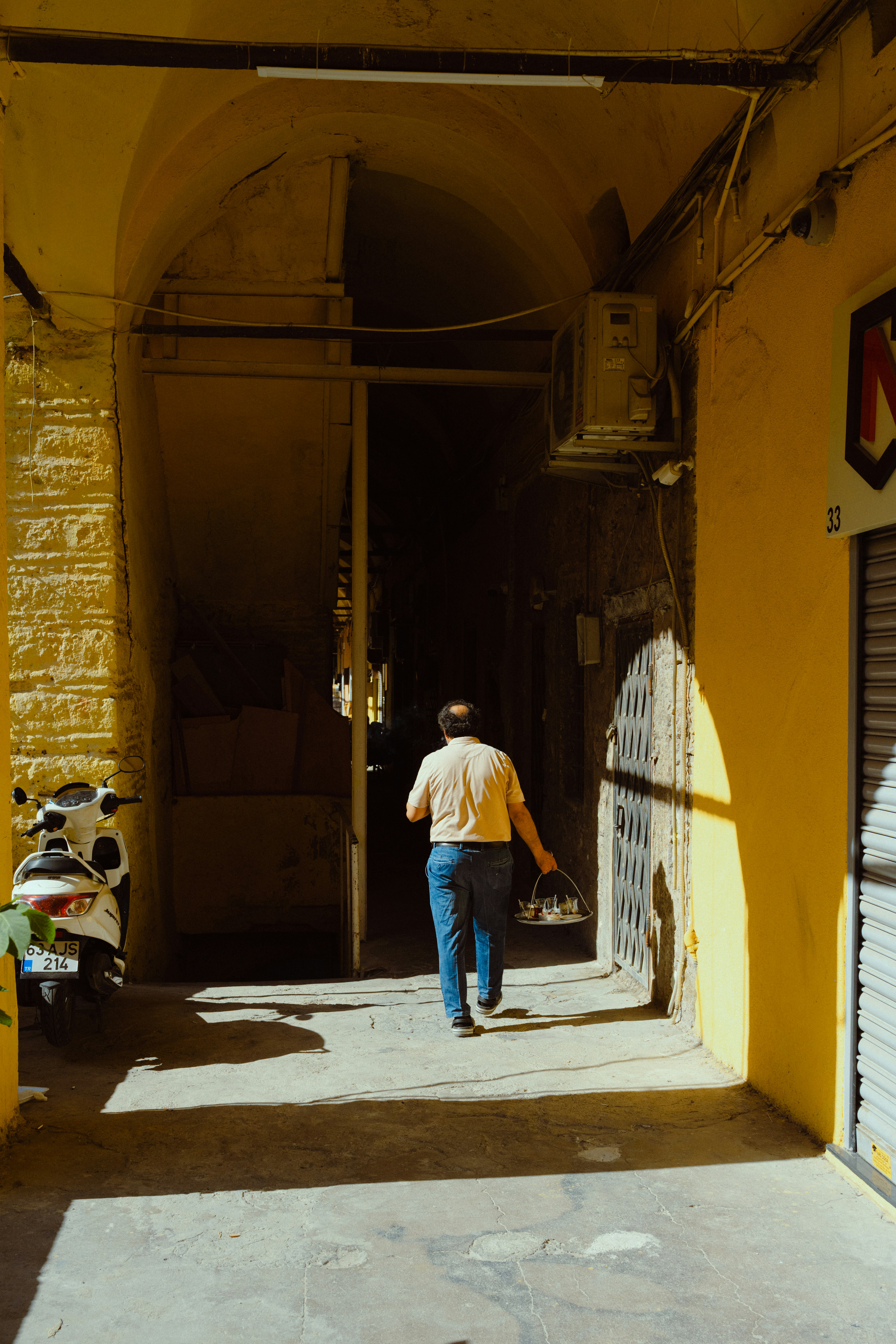 Sunlit Alleyway Sainted by a Lonesome Pedestrian