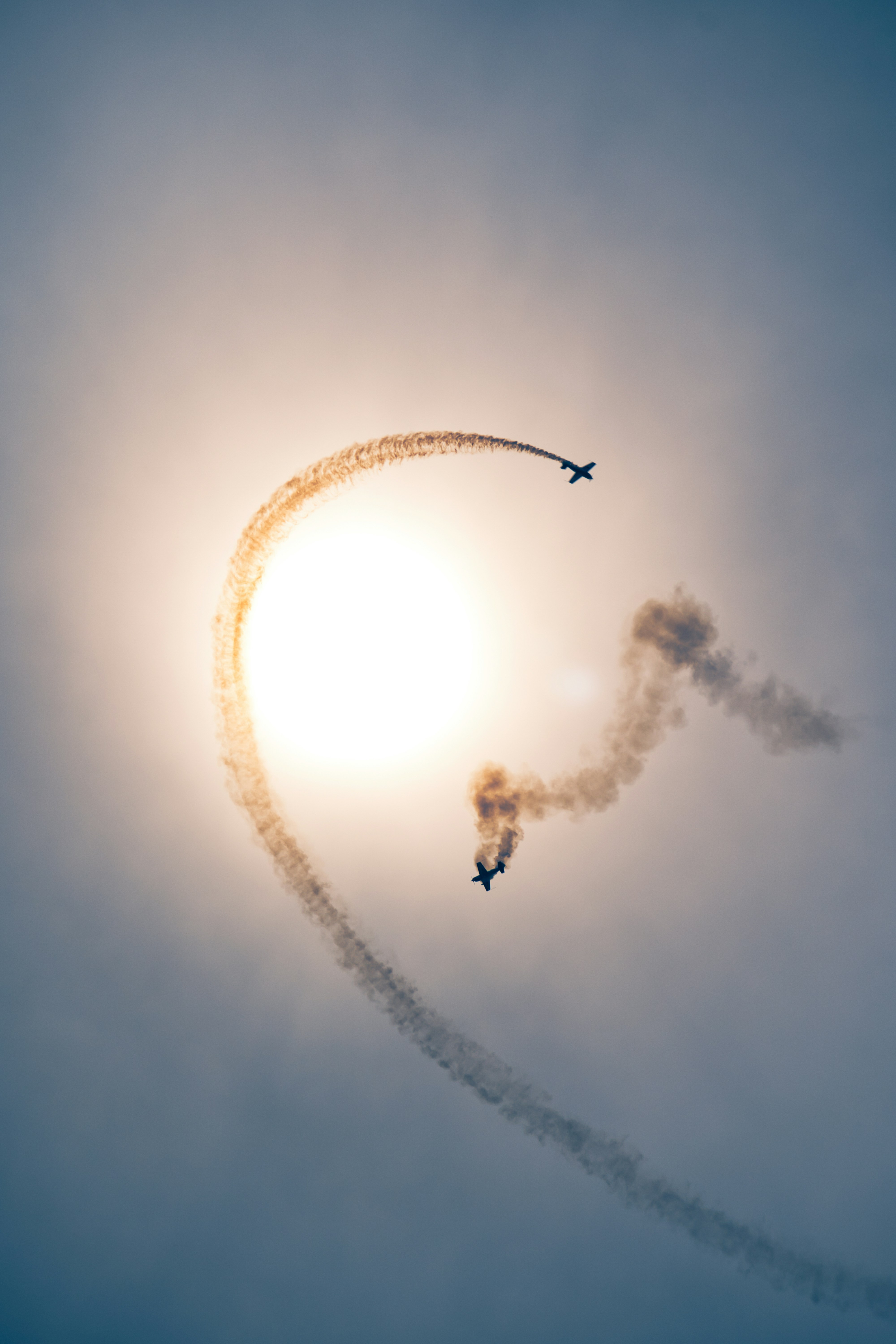 Aerial Acrobatics: Smoke Trails Weave Through a Sunlit Sky