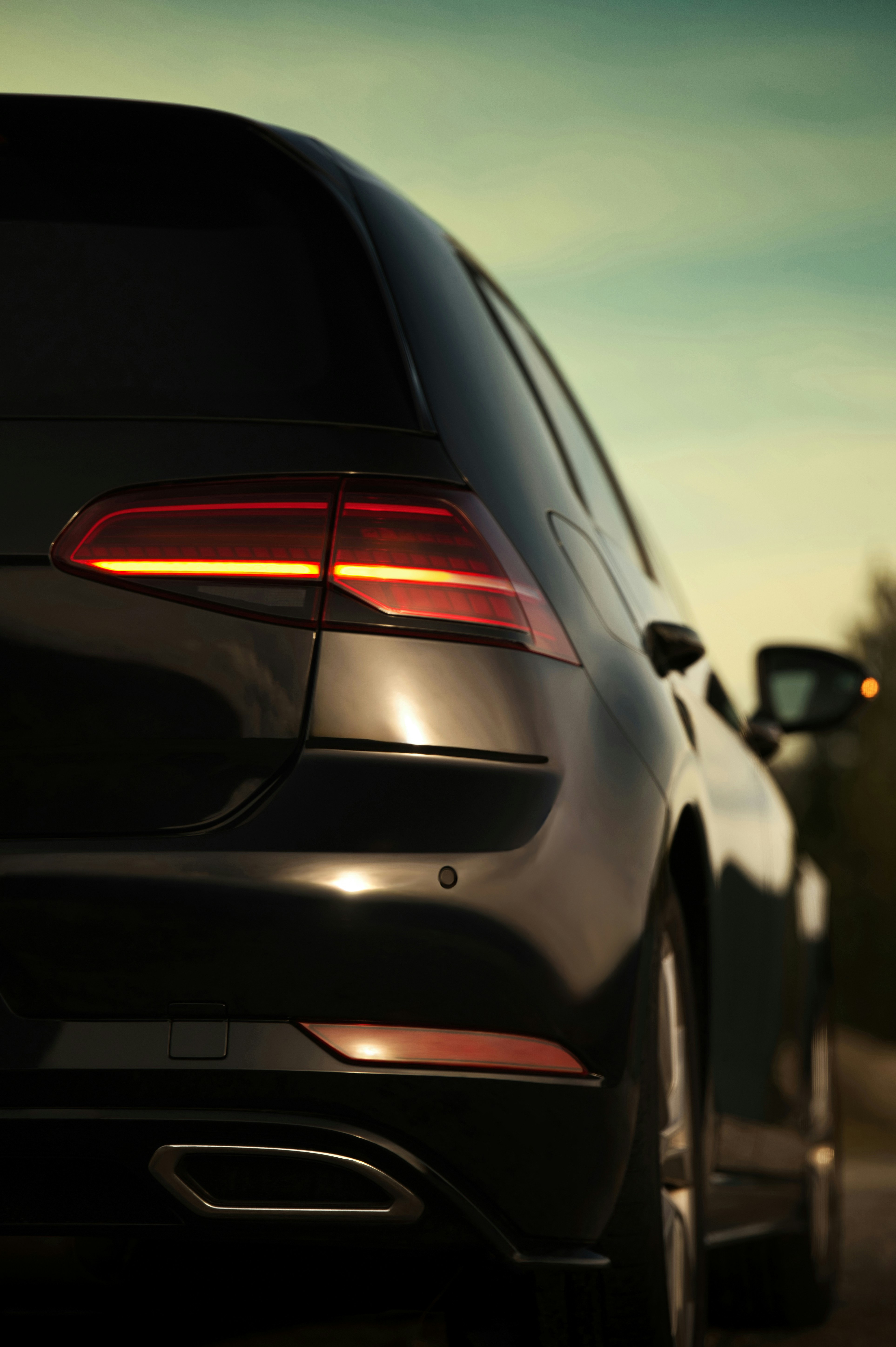 Tail Light Horizon: The Silhouette of a Porsche-like SUV at Dusk