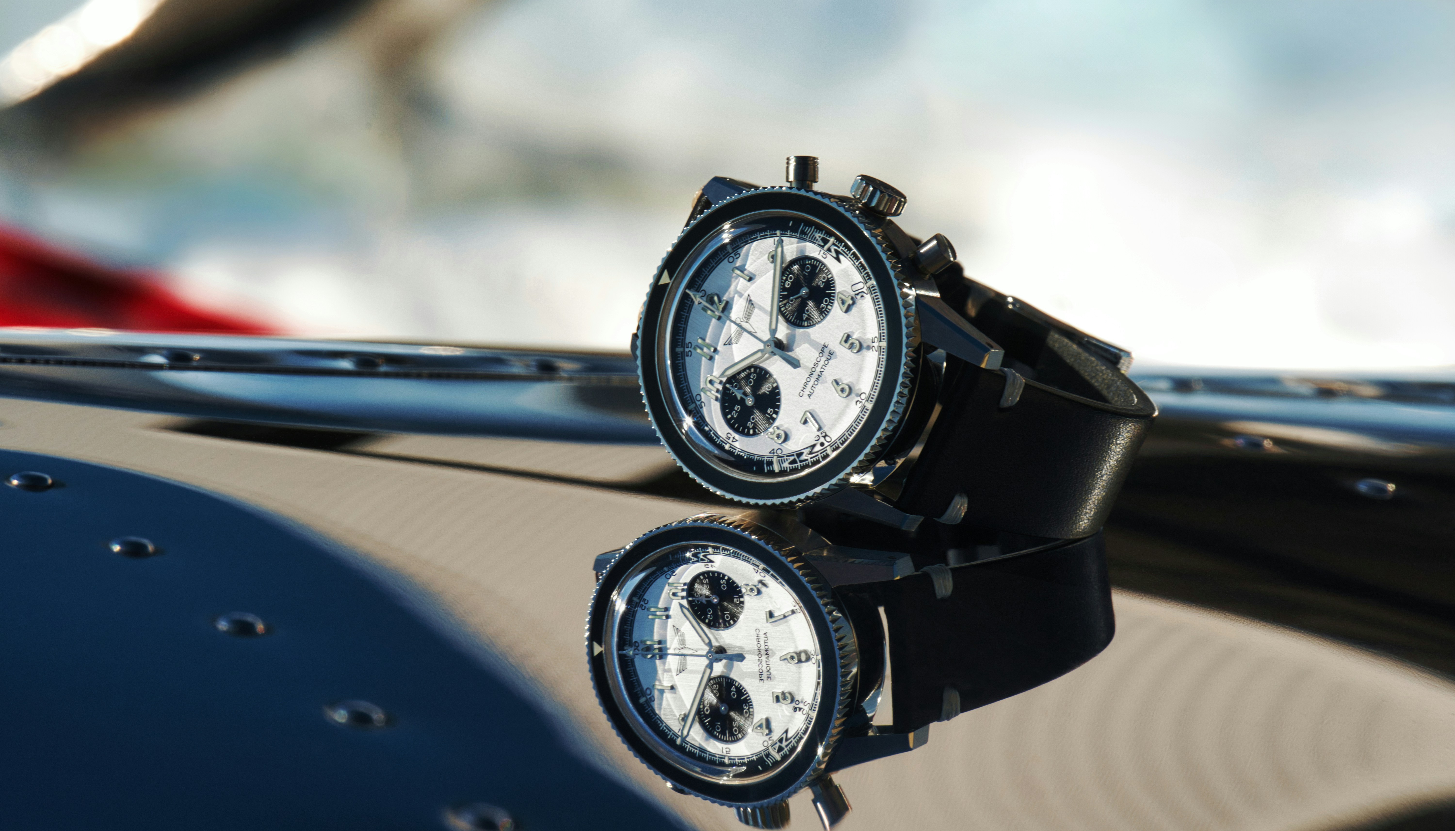Twin Timekeepers Reflecting on a Wind-Swept Windshield
