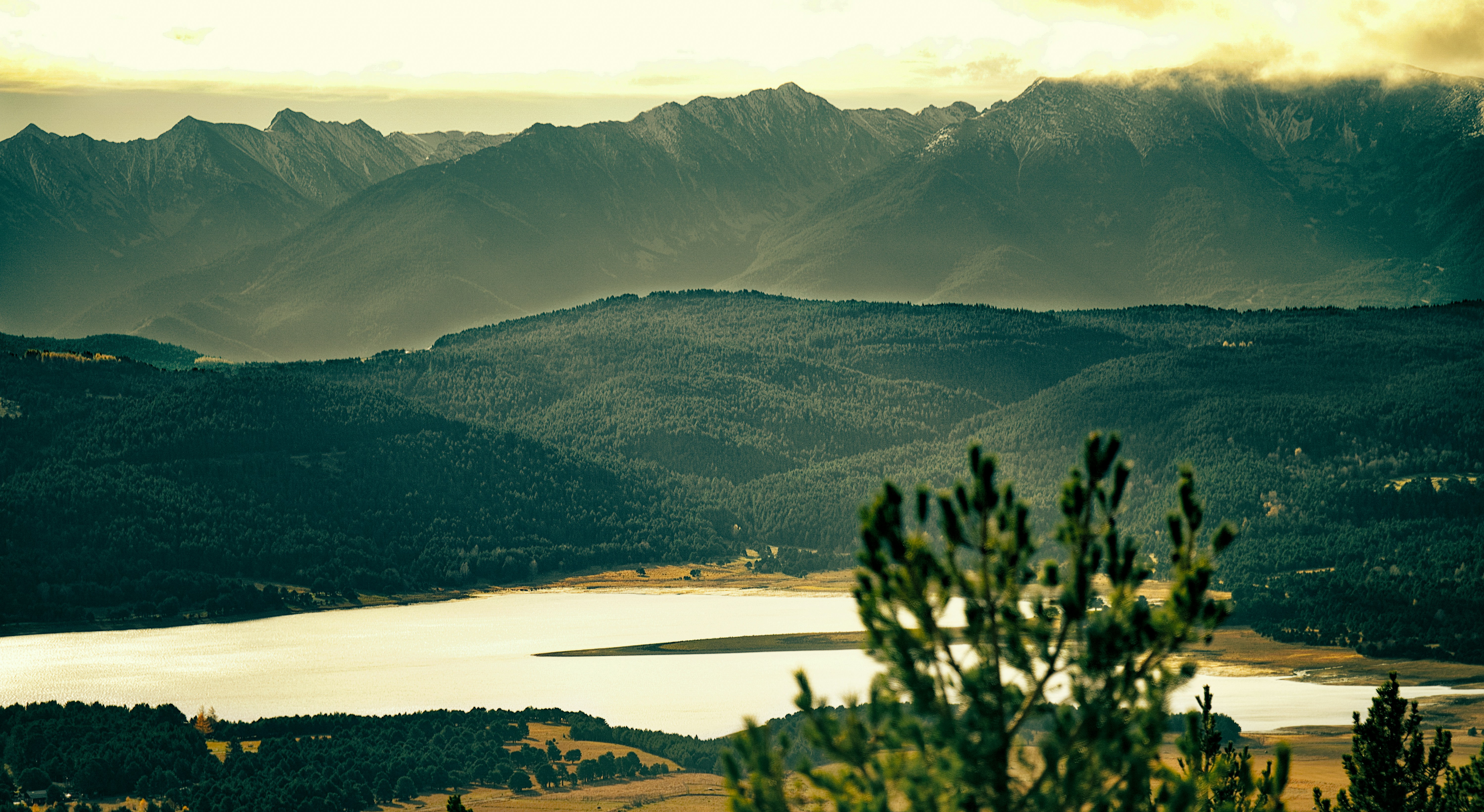 Mist-veiled Peaks Over a Serene Lake