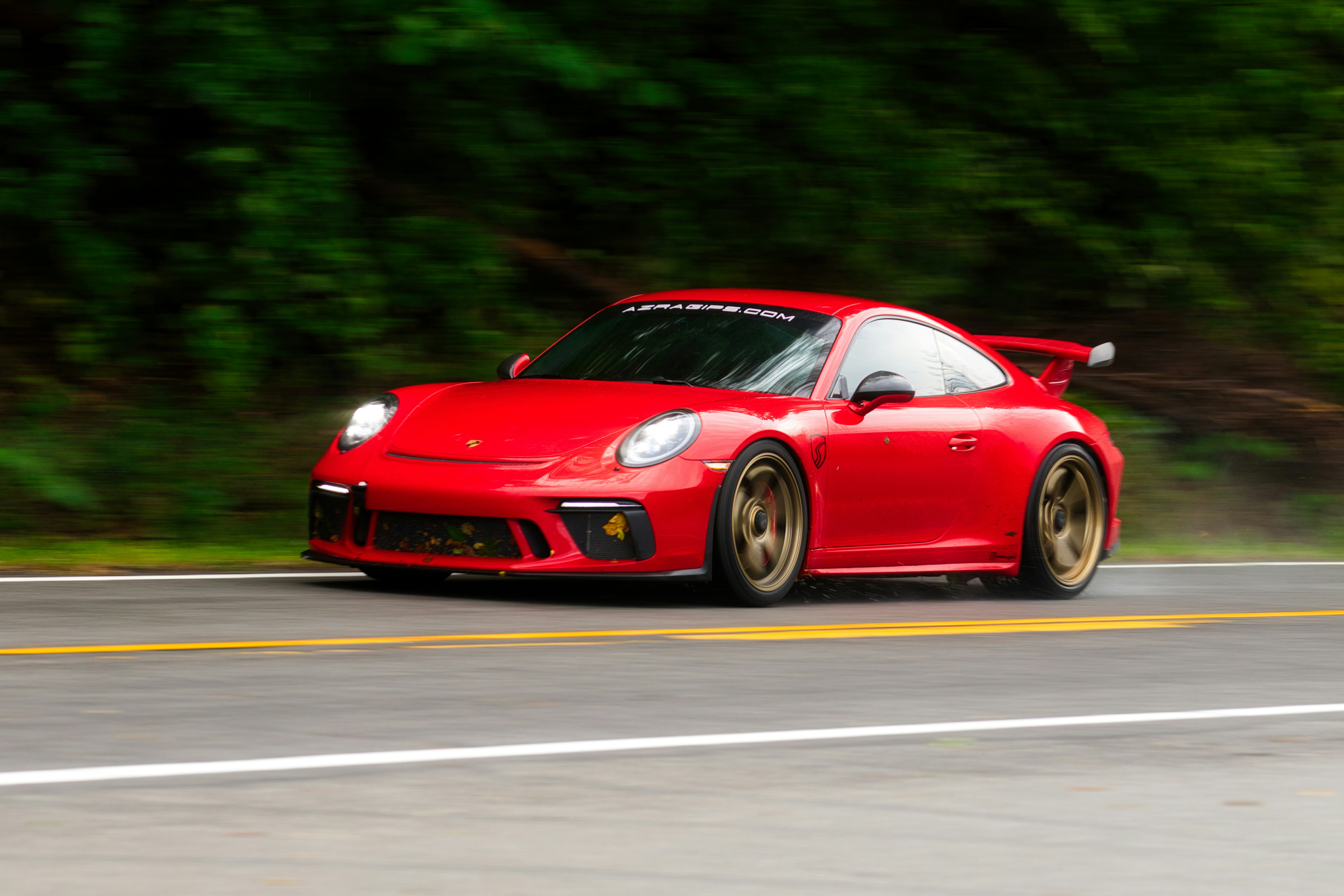 Red Rocket on a Painted Lane: A Porsche 911 GT3 RS in Motion