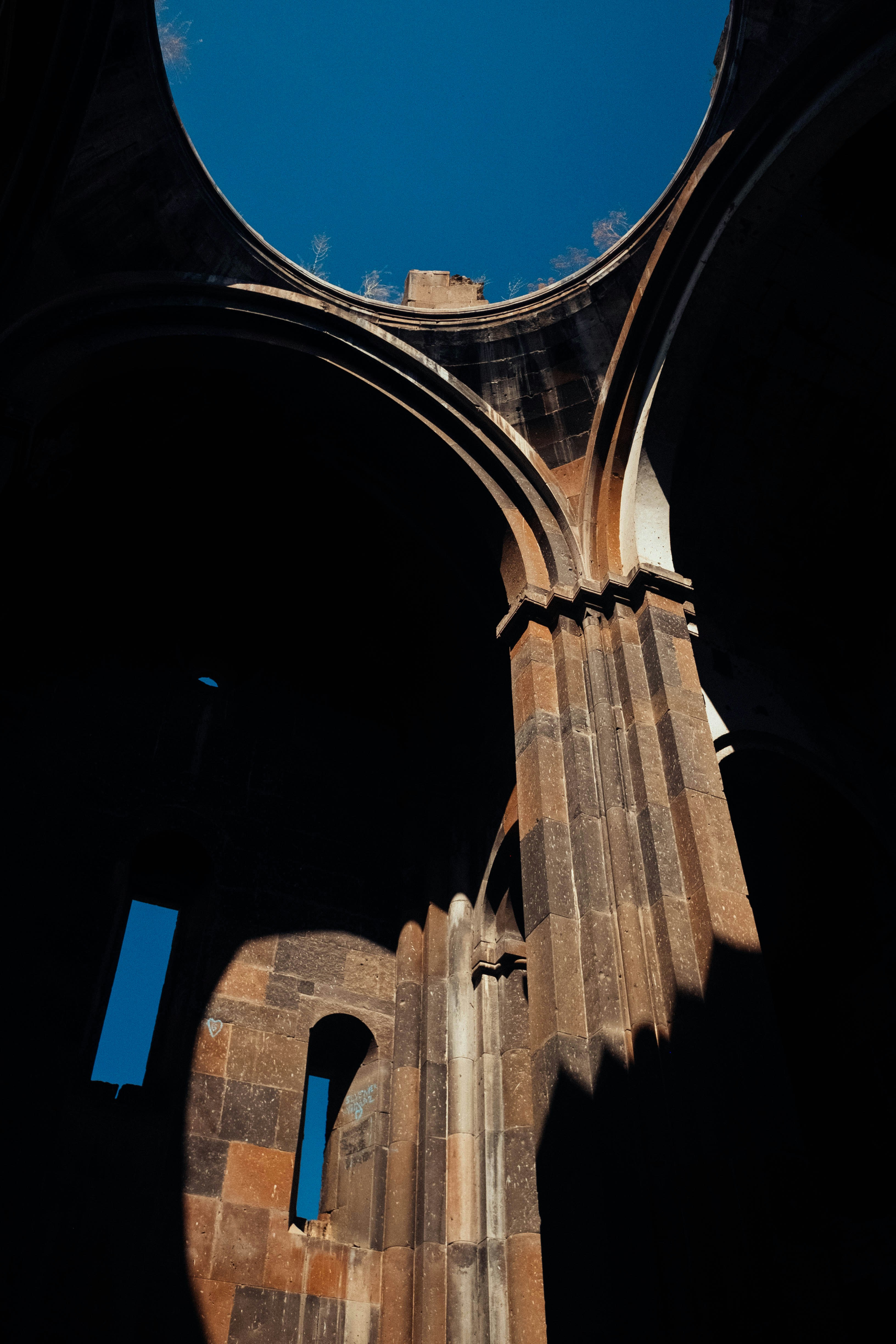 Skyward Archways: Light and Shadow Play in a Desolate Ruin