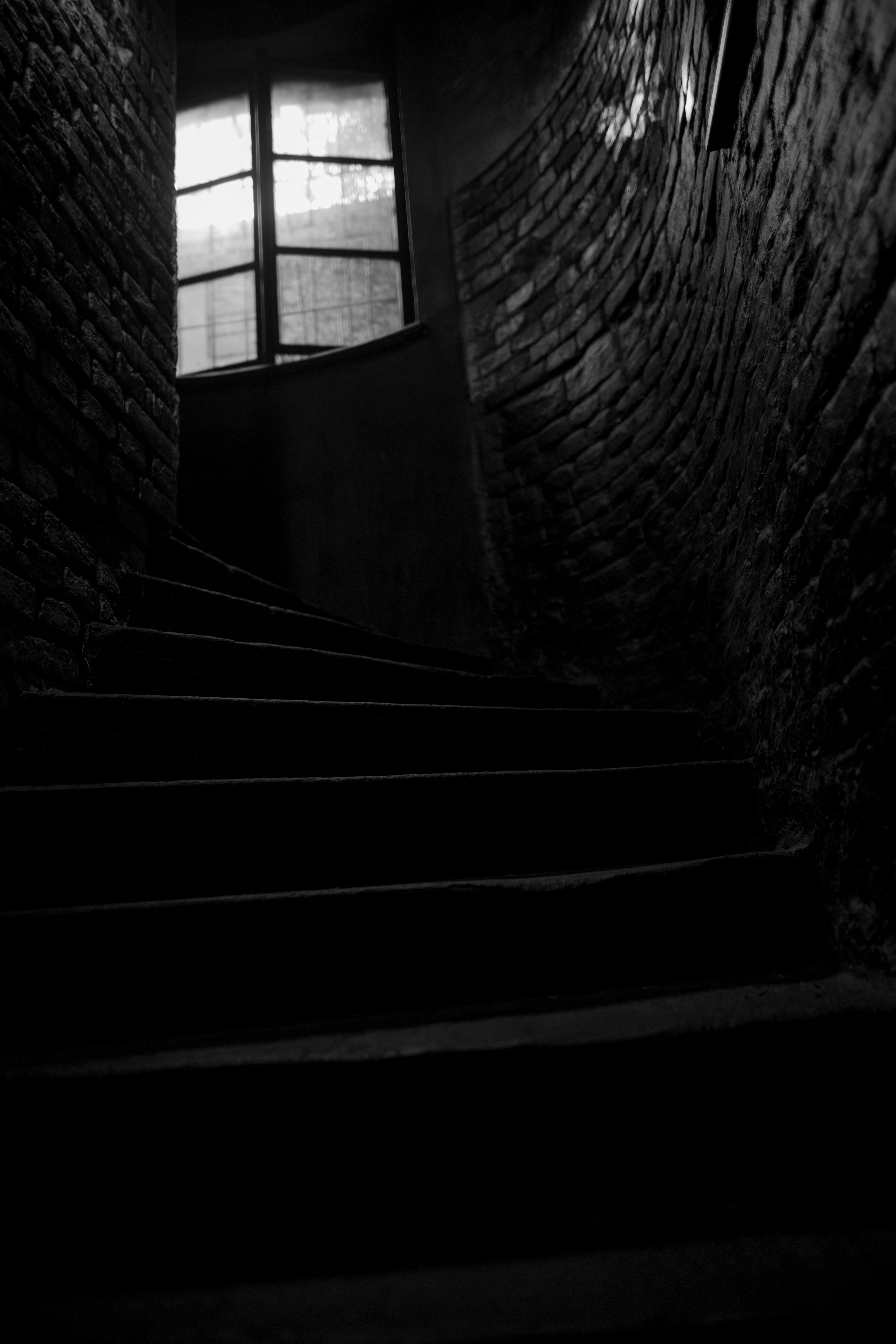 Midnight Stairwell: A Windowed Escape from Brick Walls