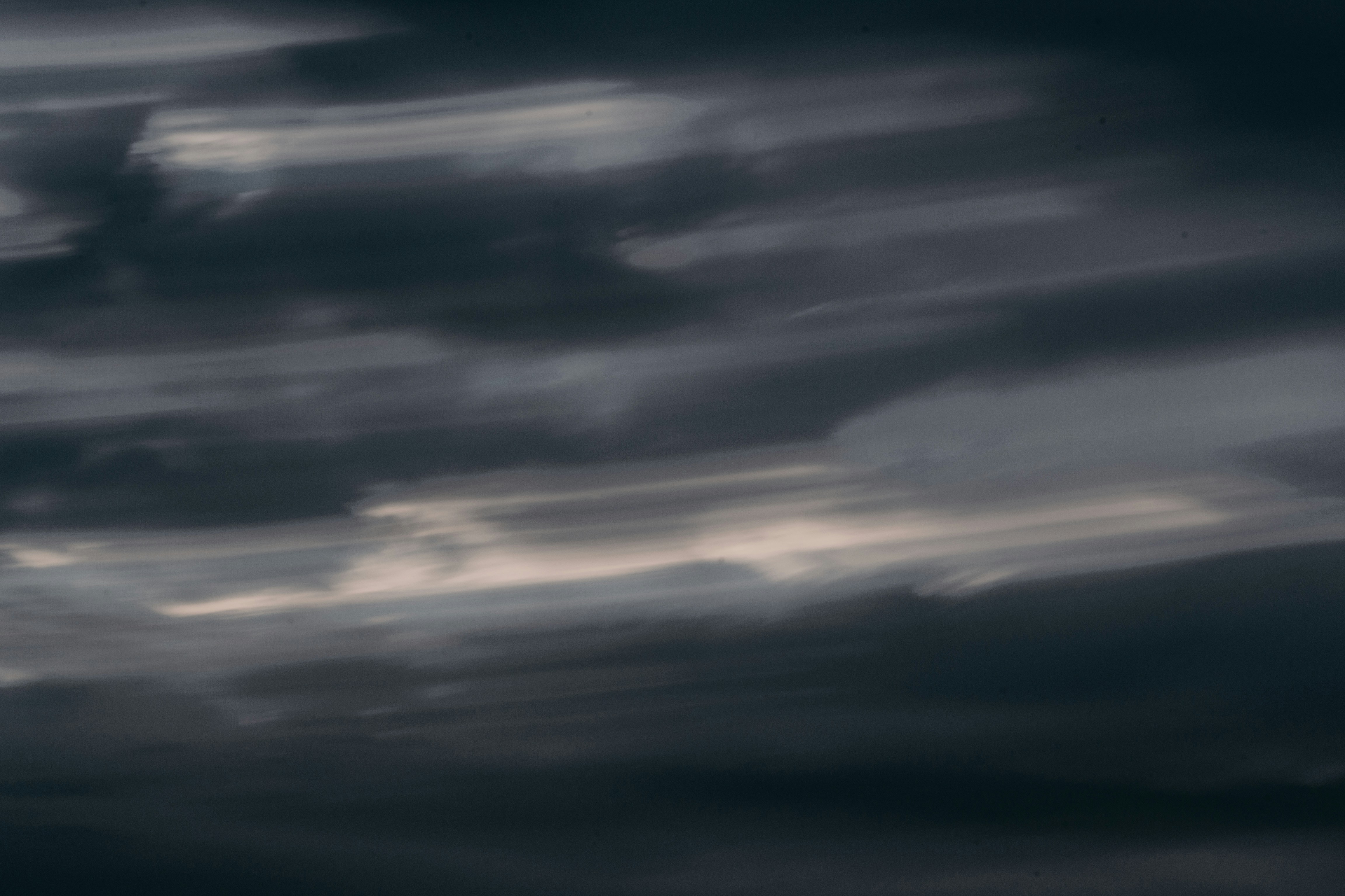 Low-Light Blur: Soft Strata of Moving Clouds Across a Dusk Sky