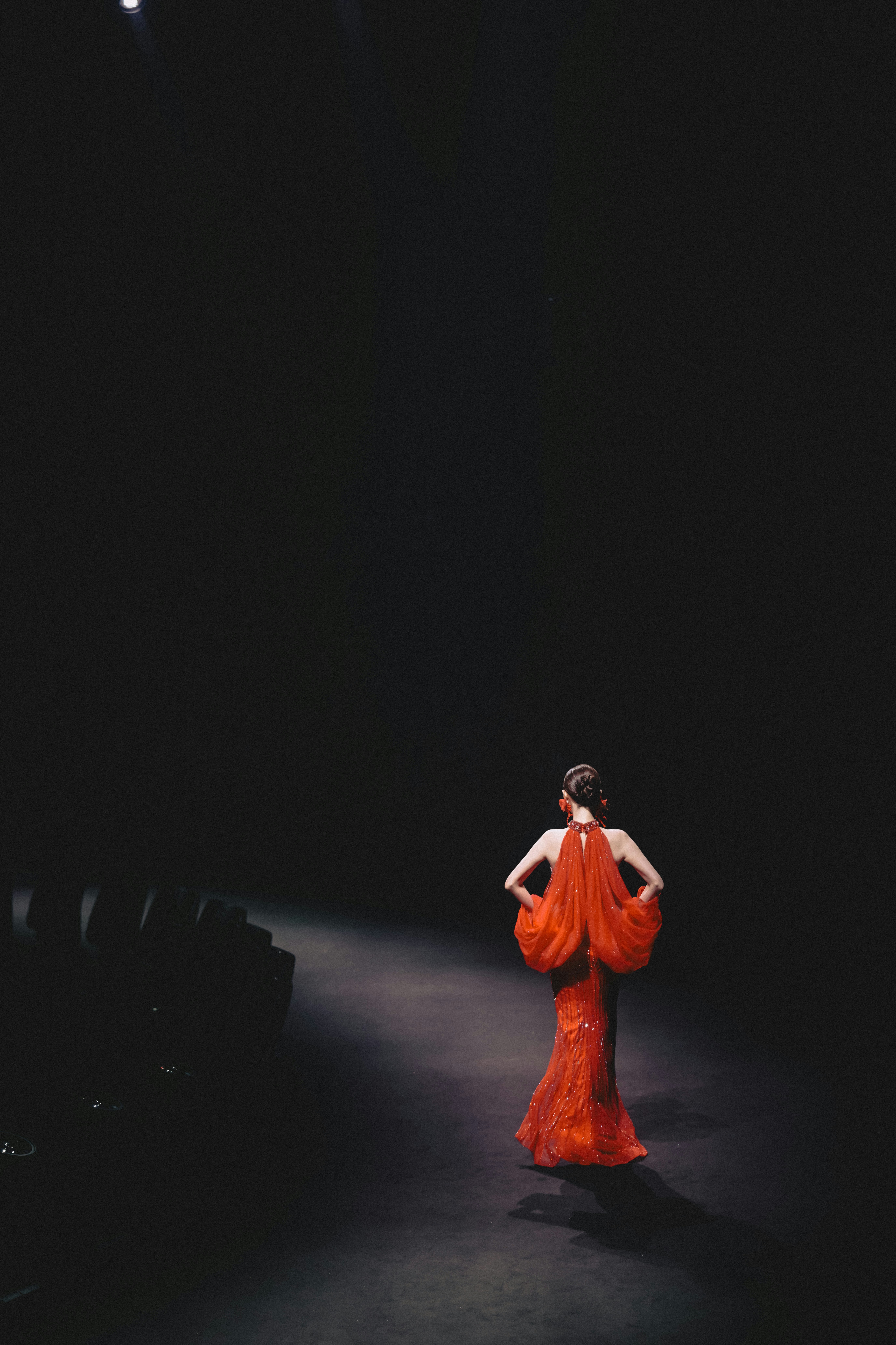 Red Velvet Catwalk: A Solitary Gown Illuminates the Stage