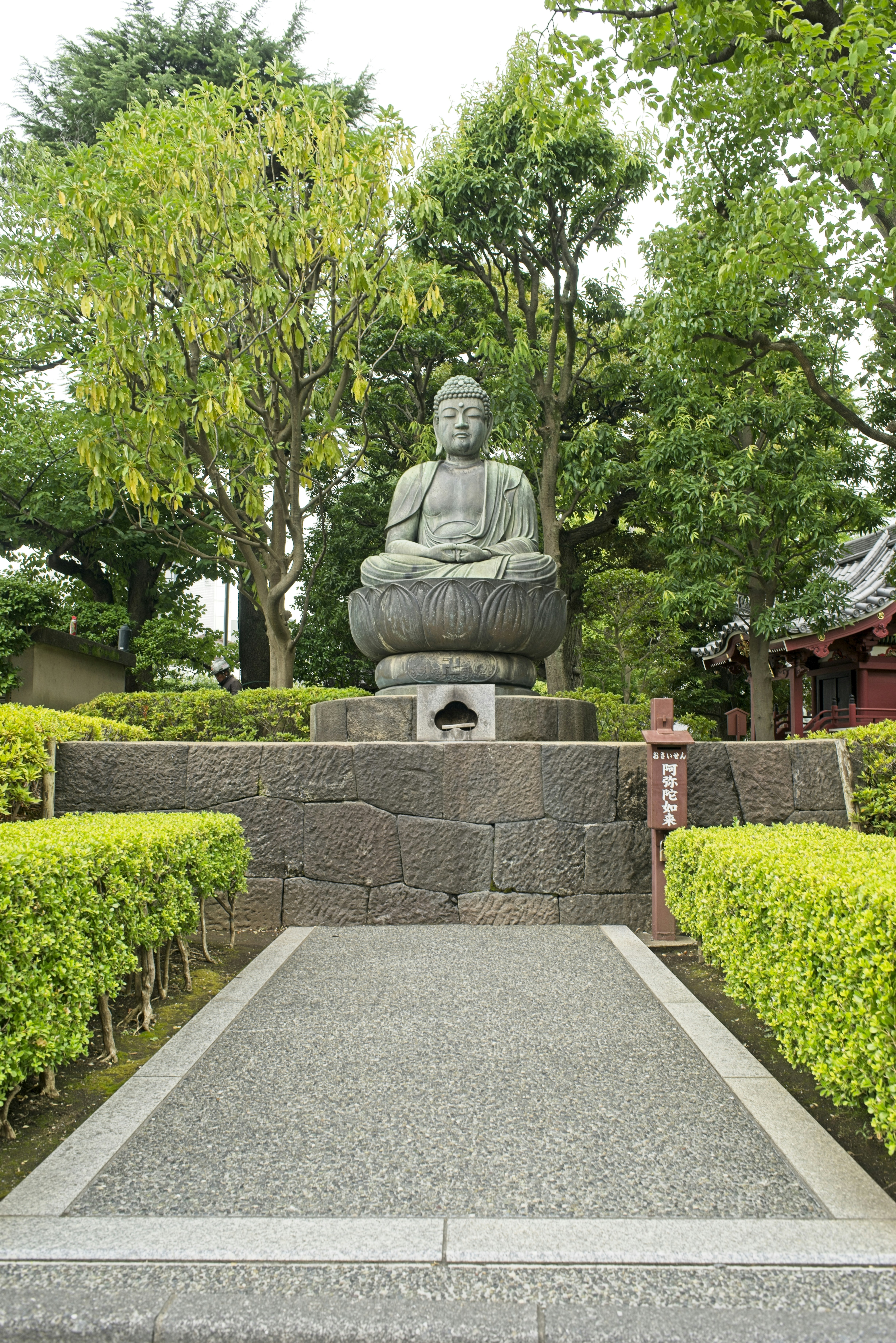 Stone Buddha at the Garden Altar: Pathway to Serenity