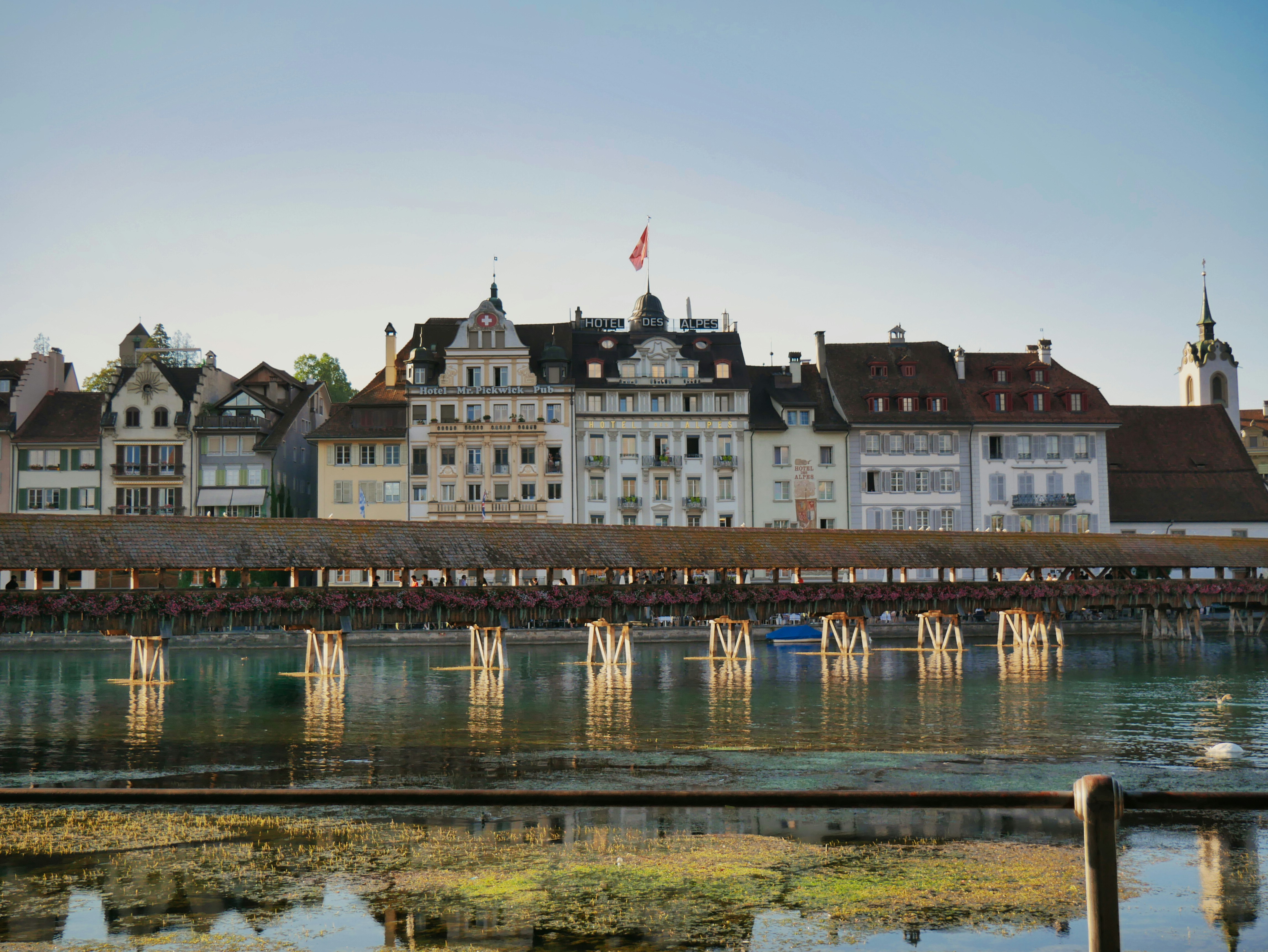 Row of Swiss-style Facades Over a Tranquil Lake Pier