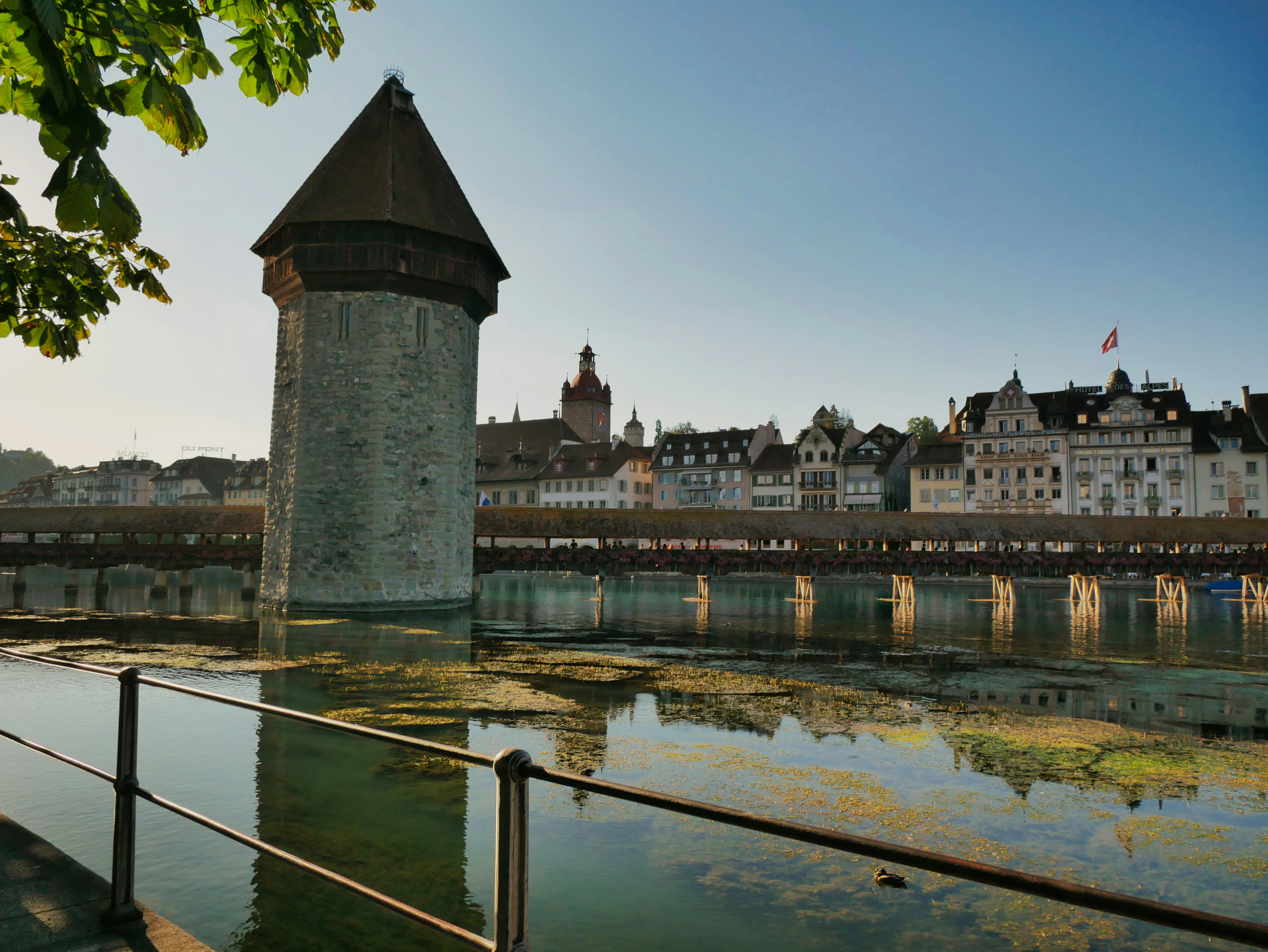 Tower and Town Reflections: A Tranquil Swiss-Italy Riverfront