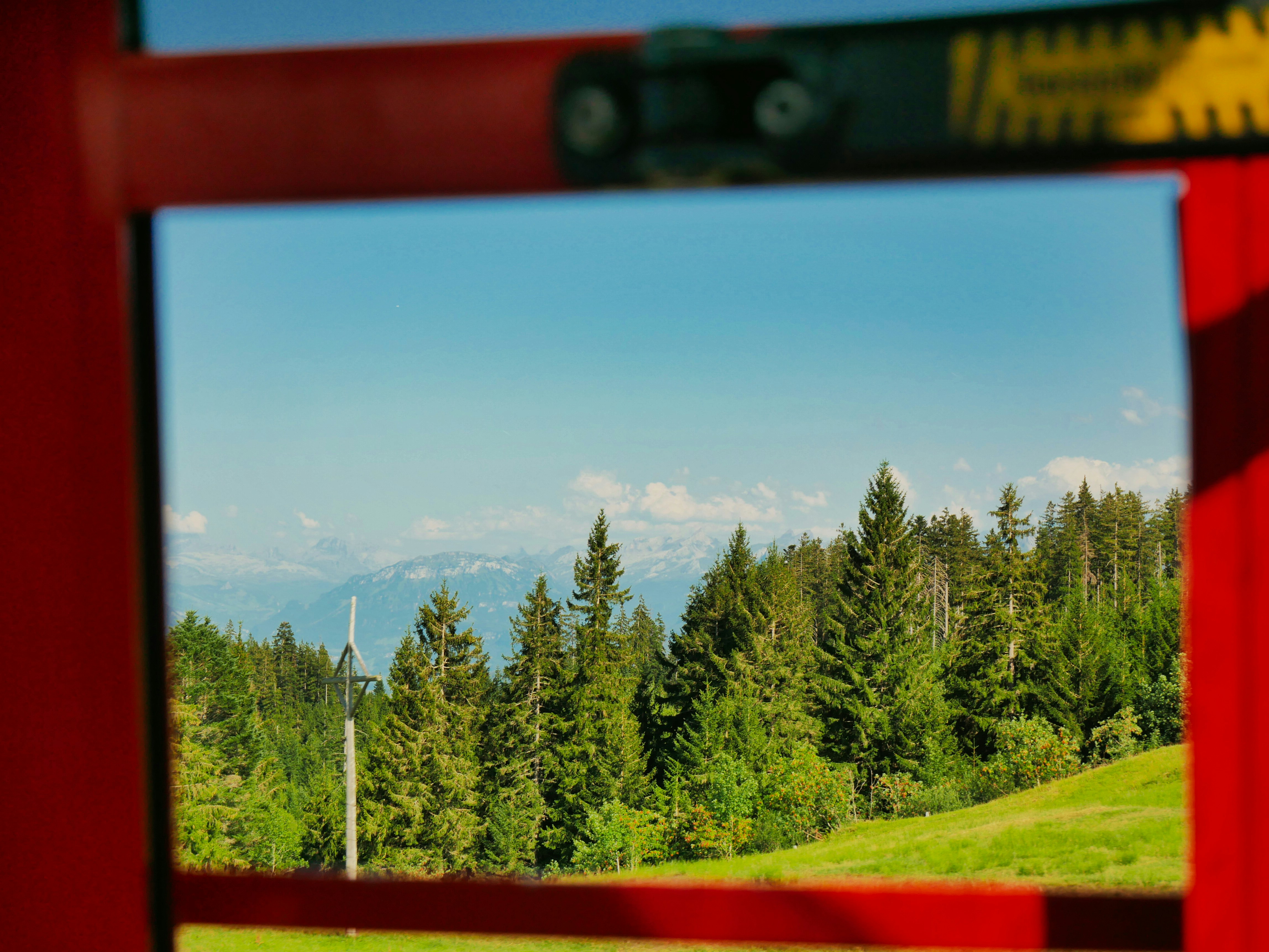 Red Frame, Green Vista: A Window onto Alpine Calm