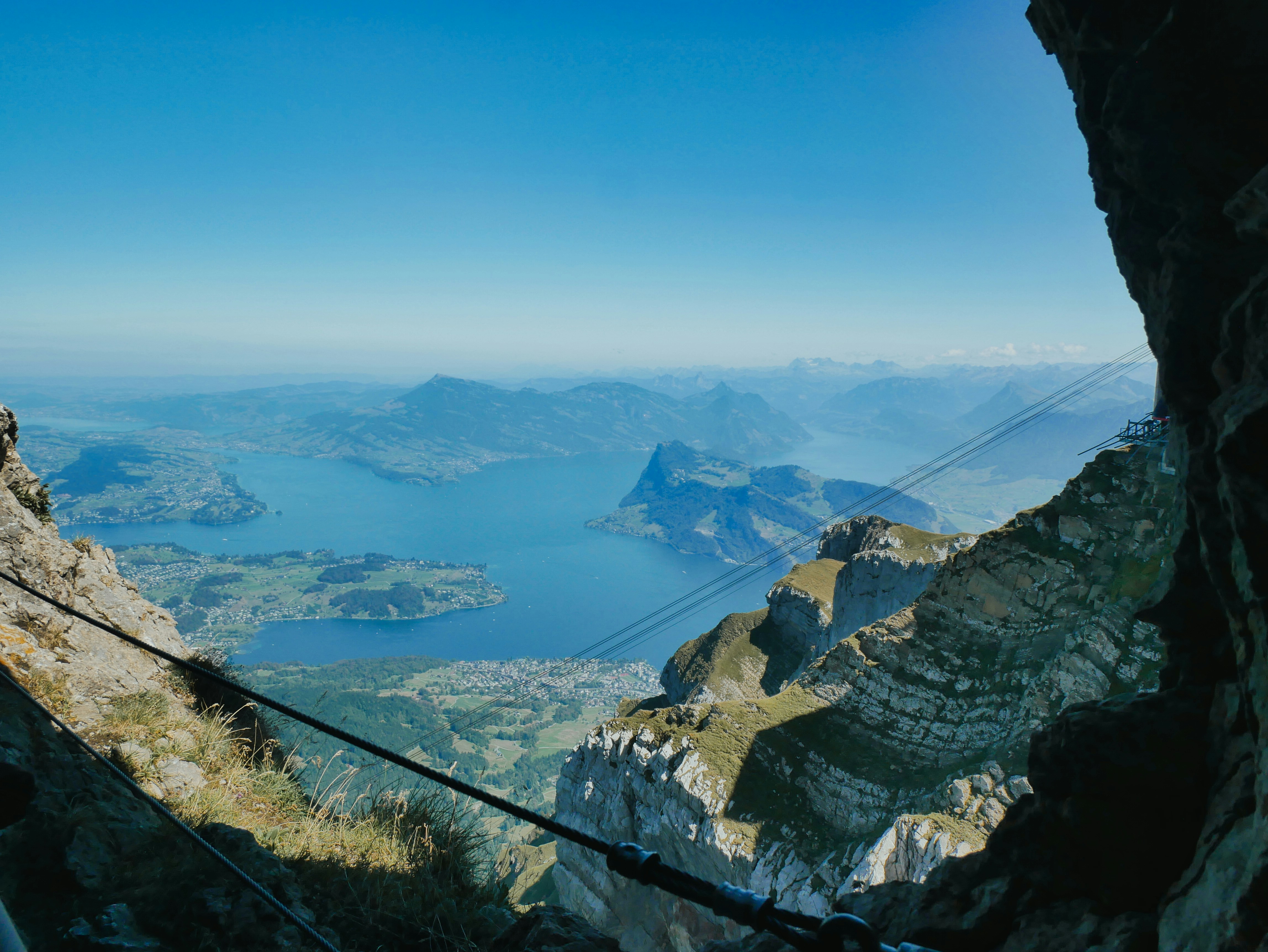 Cliffside Cable and Summit Veil Over a Blue Fjord