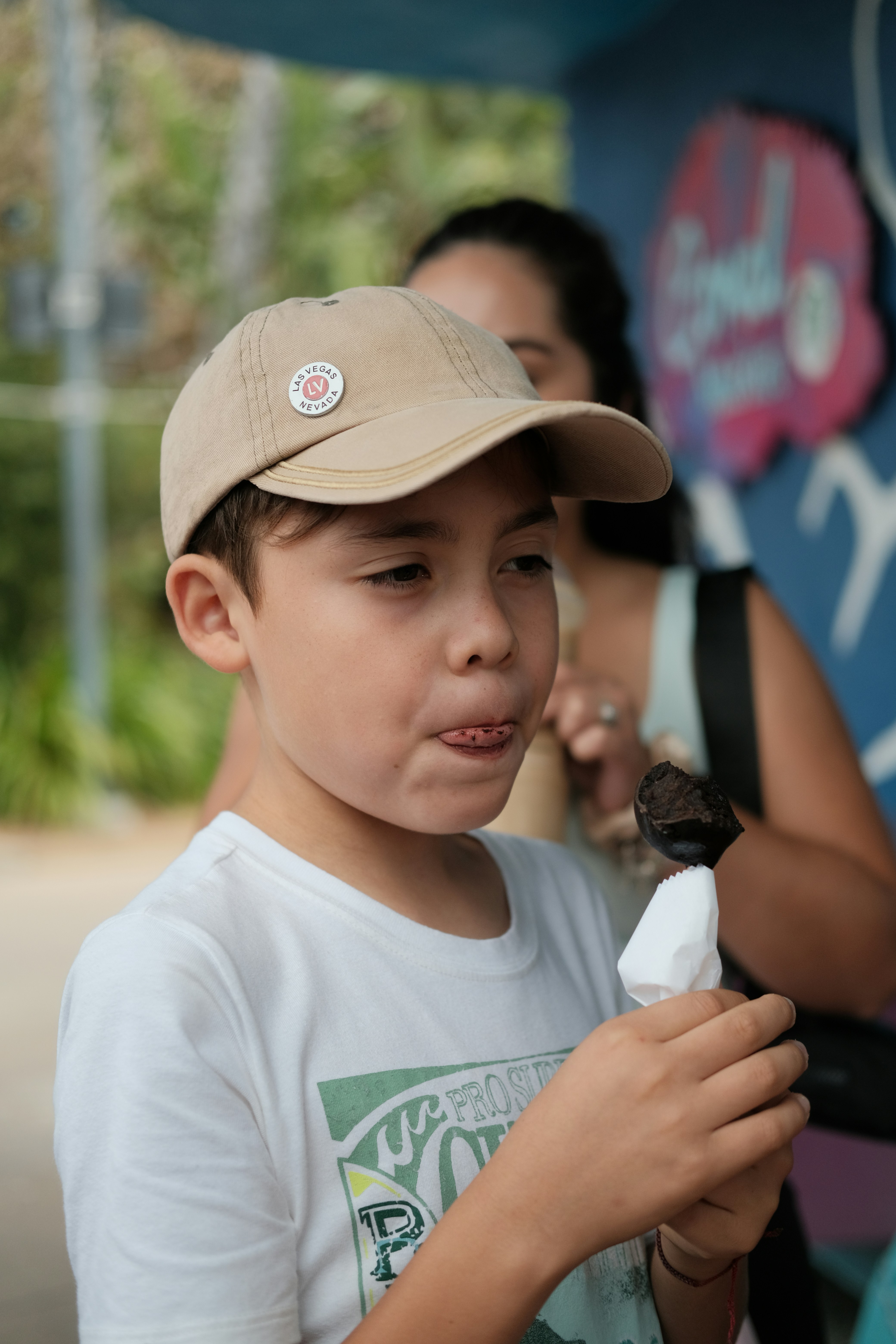 Soft Chocolate Smile: Boy with Ice Cream Hat in Focus