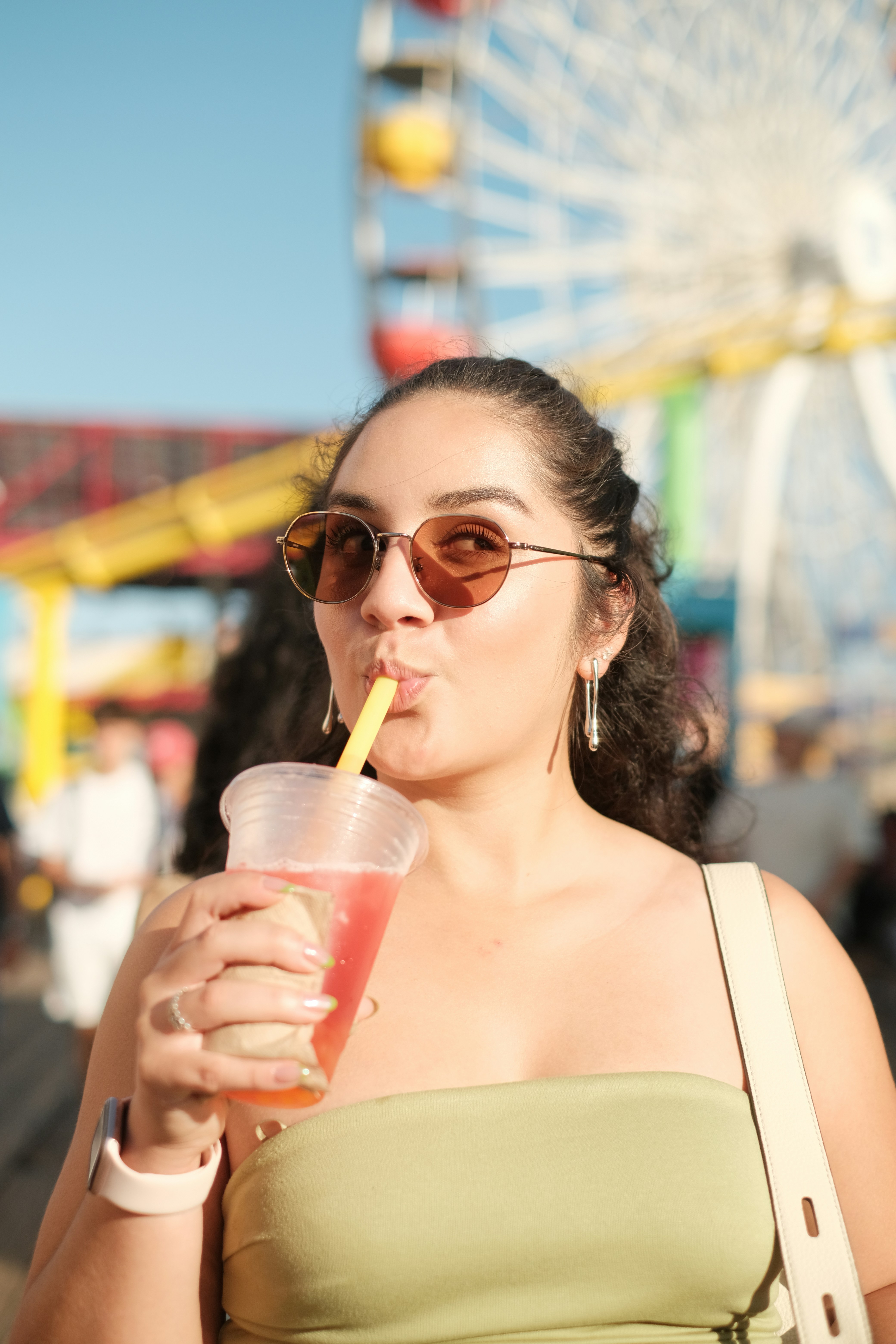 Sunlit Sipper: A Fashionable Moment at the Amusement Park