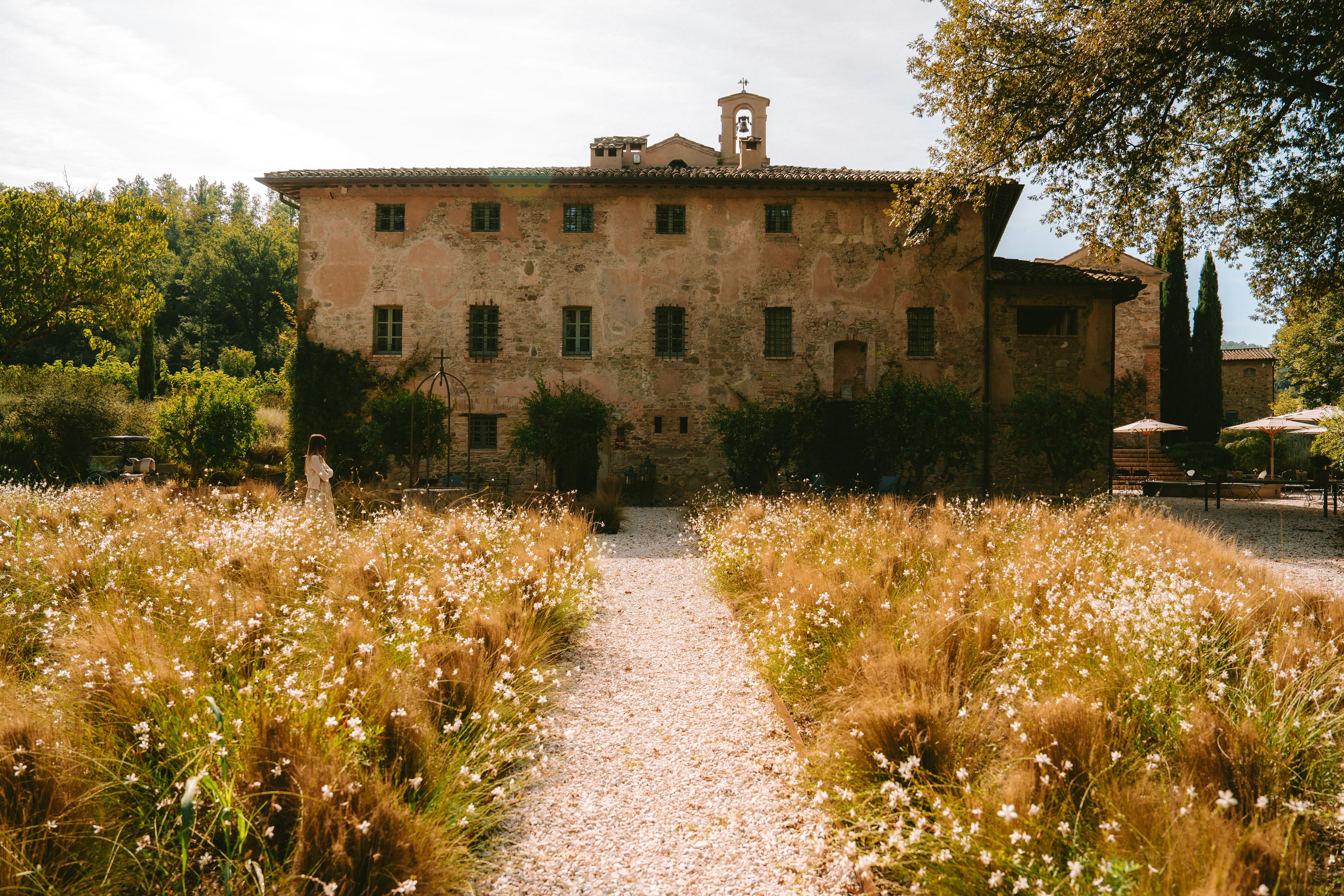 Sunlit Courtyard Approach to a Tuscan-Style Estate