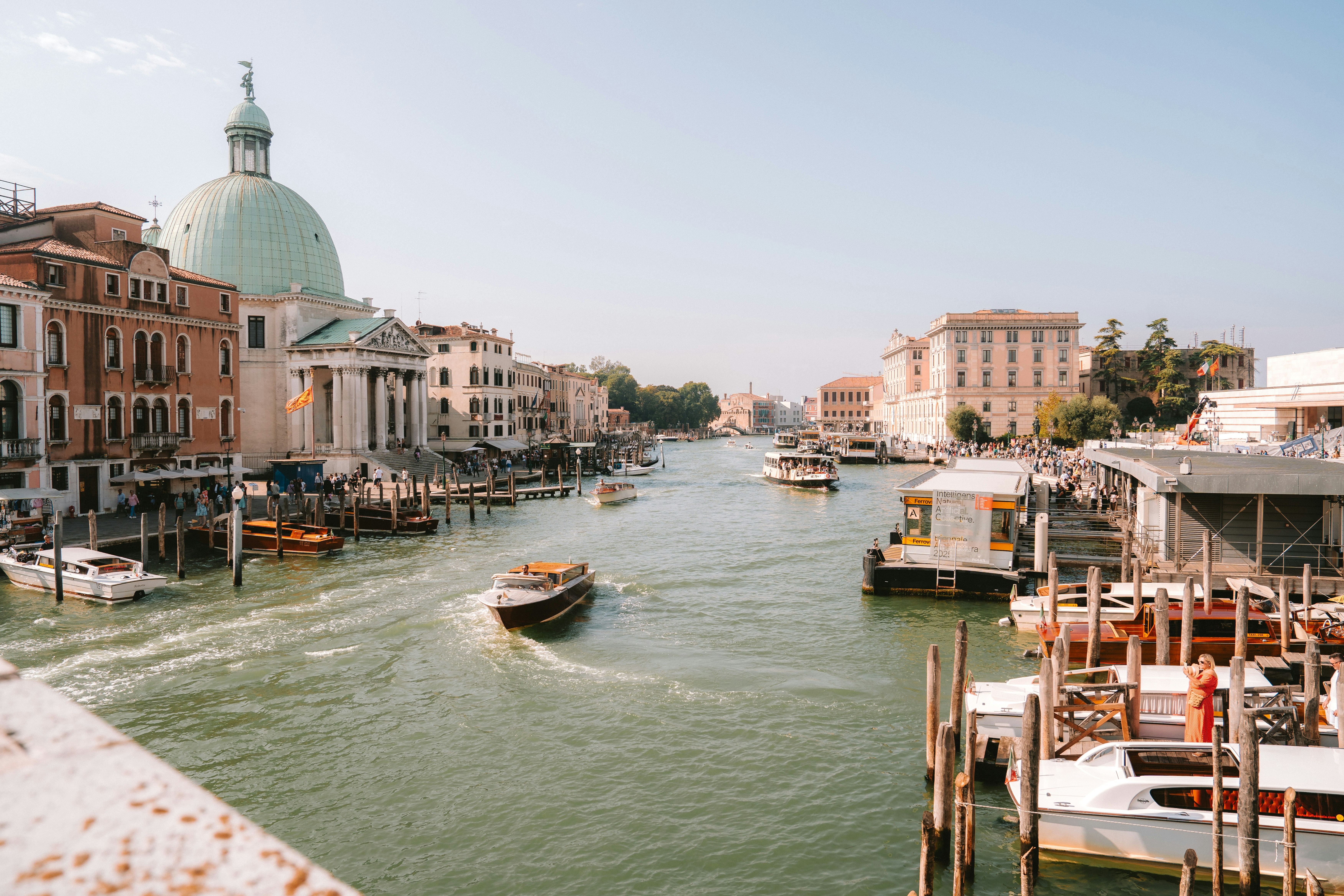 Canal Confluence: Boats, Bridges, and a Domed Skyline