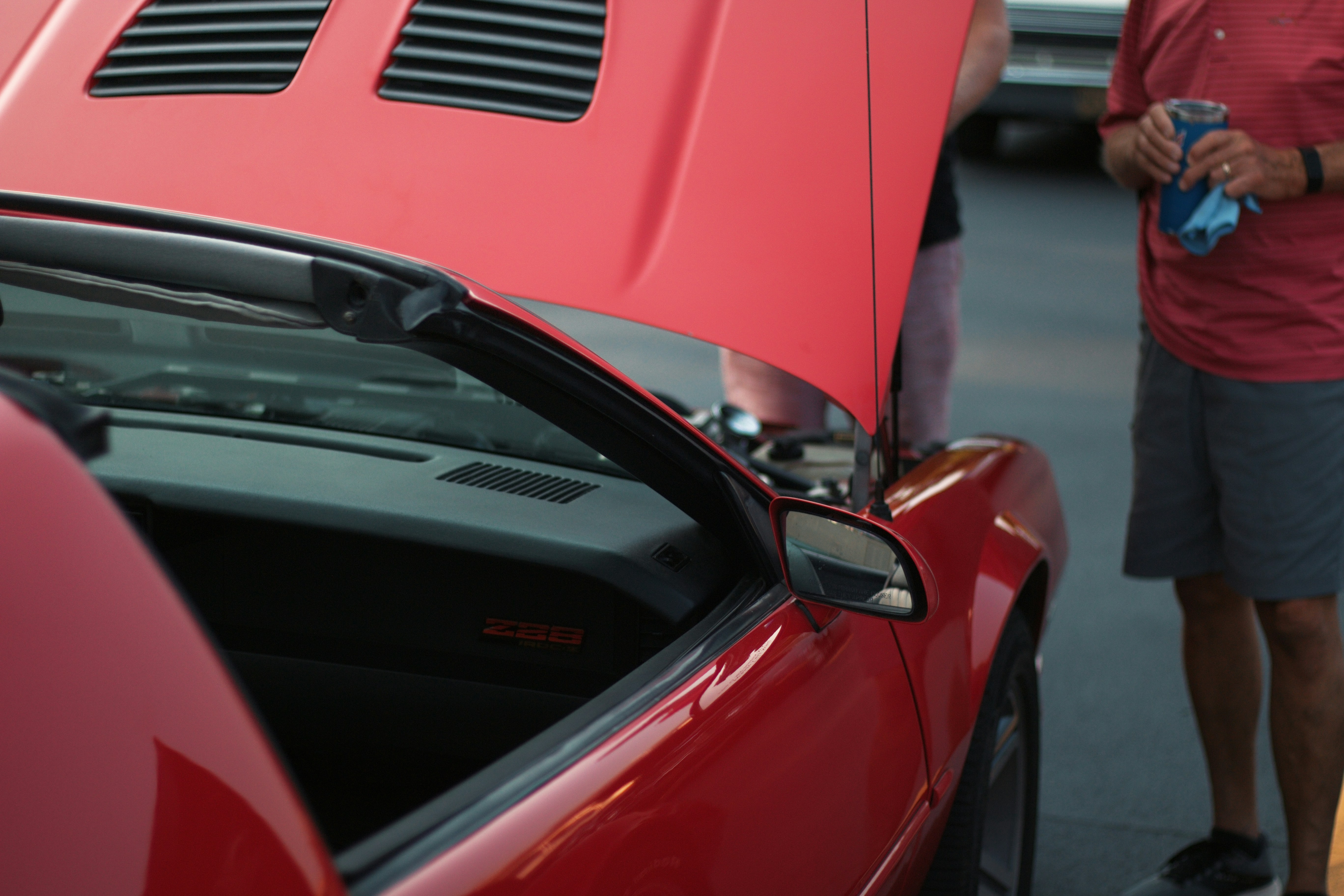 Hood Raised, Red Corvette Details in Focus