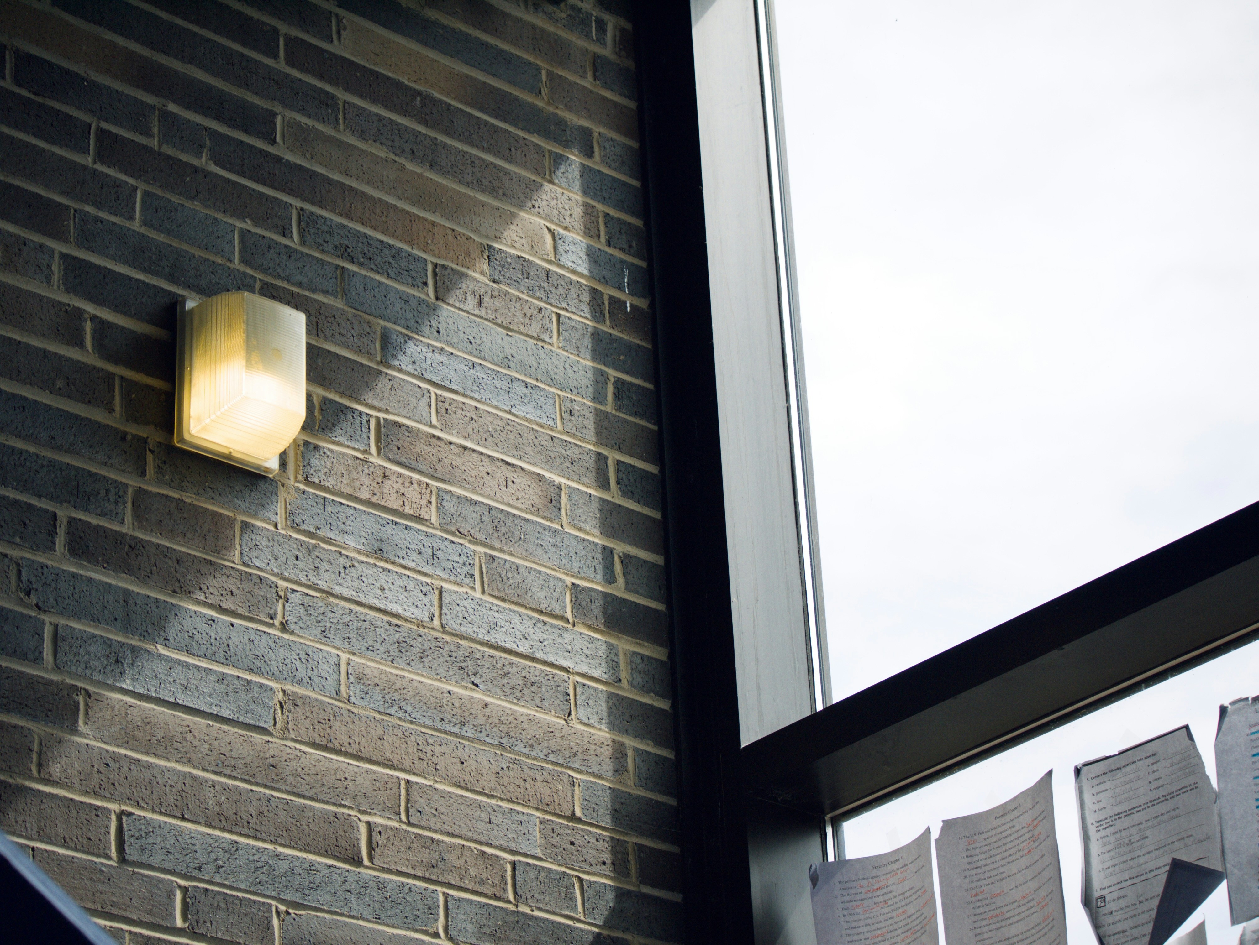 Edge of Light: Brick Wall, Lamp, and Window Frame