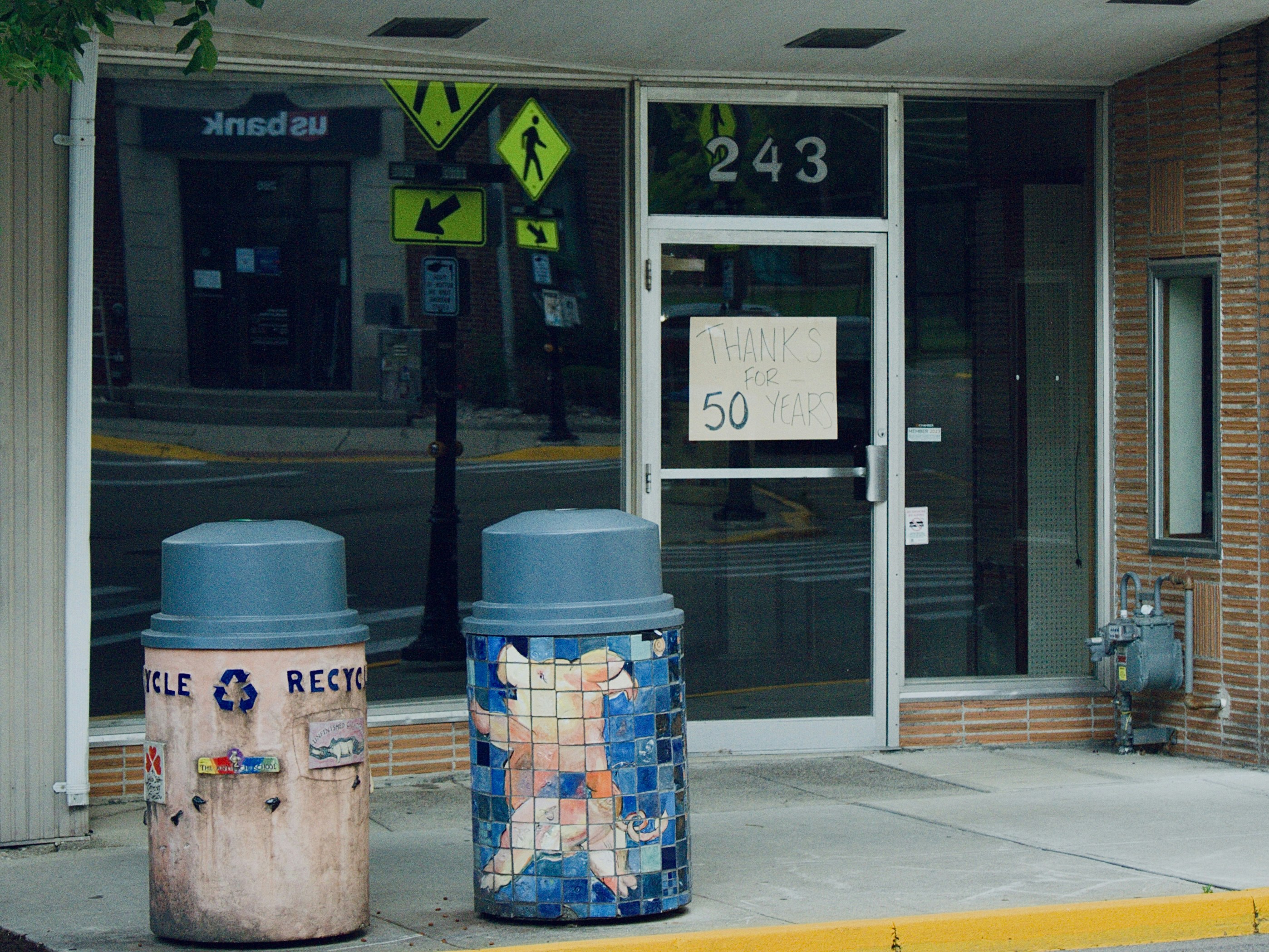 Doorway Window with Signage and Mosaic Trash Bin