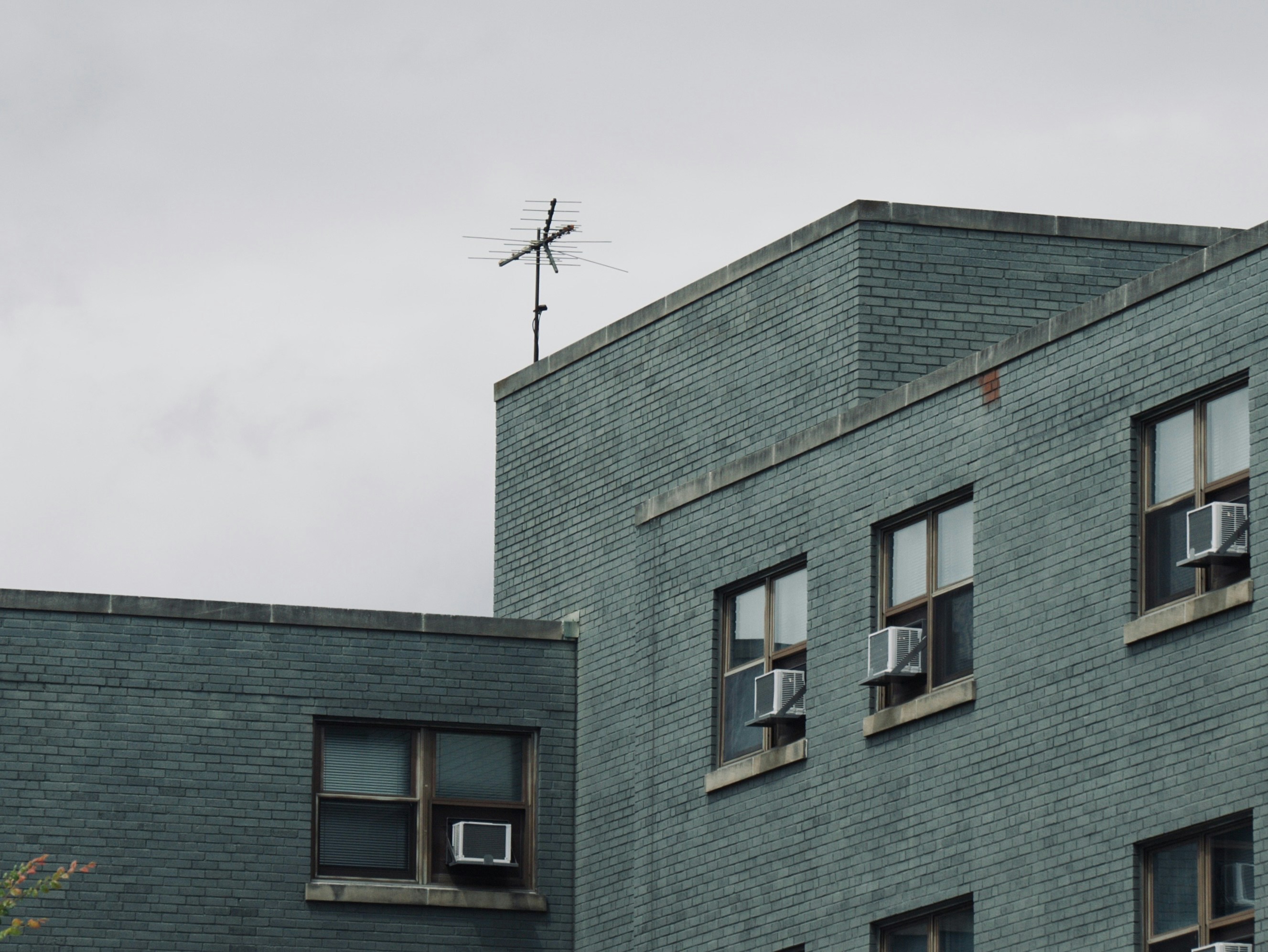 Urban Roofline: Antenna, Windows, and HVAC Echo