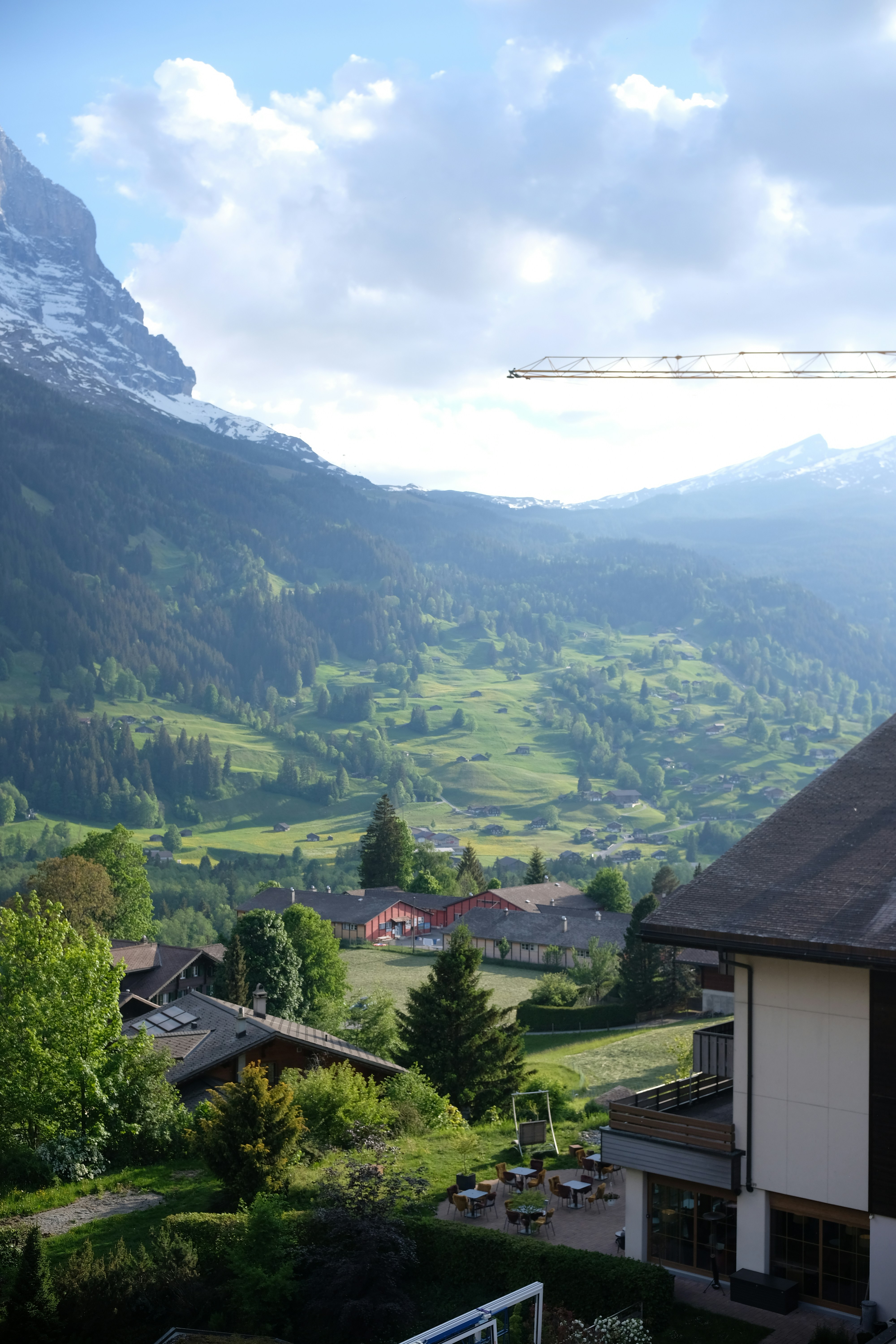 Alpine Village Terrace Beneath Snow-Capped Peaks