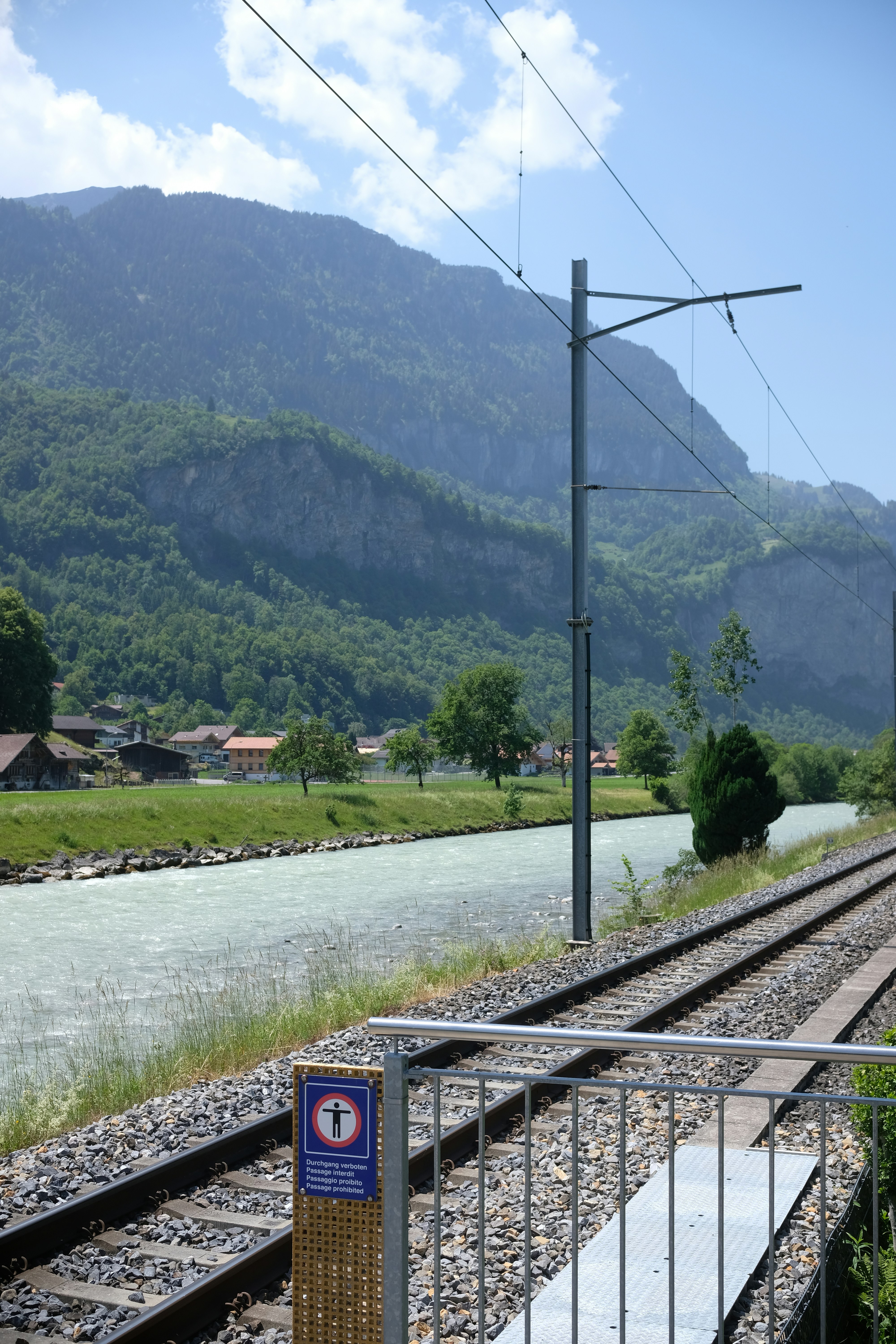 Rails Along the River: A Mountain Village Under Cables