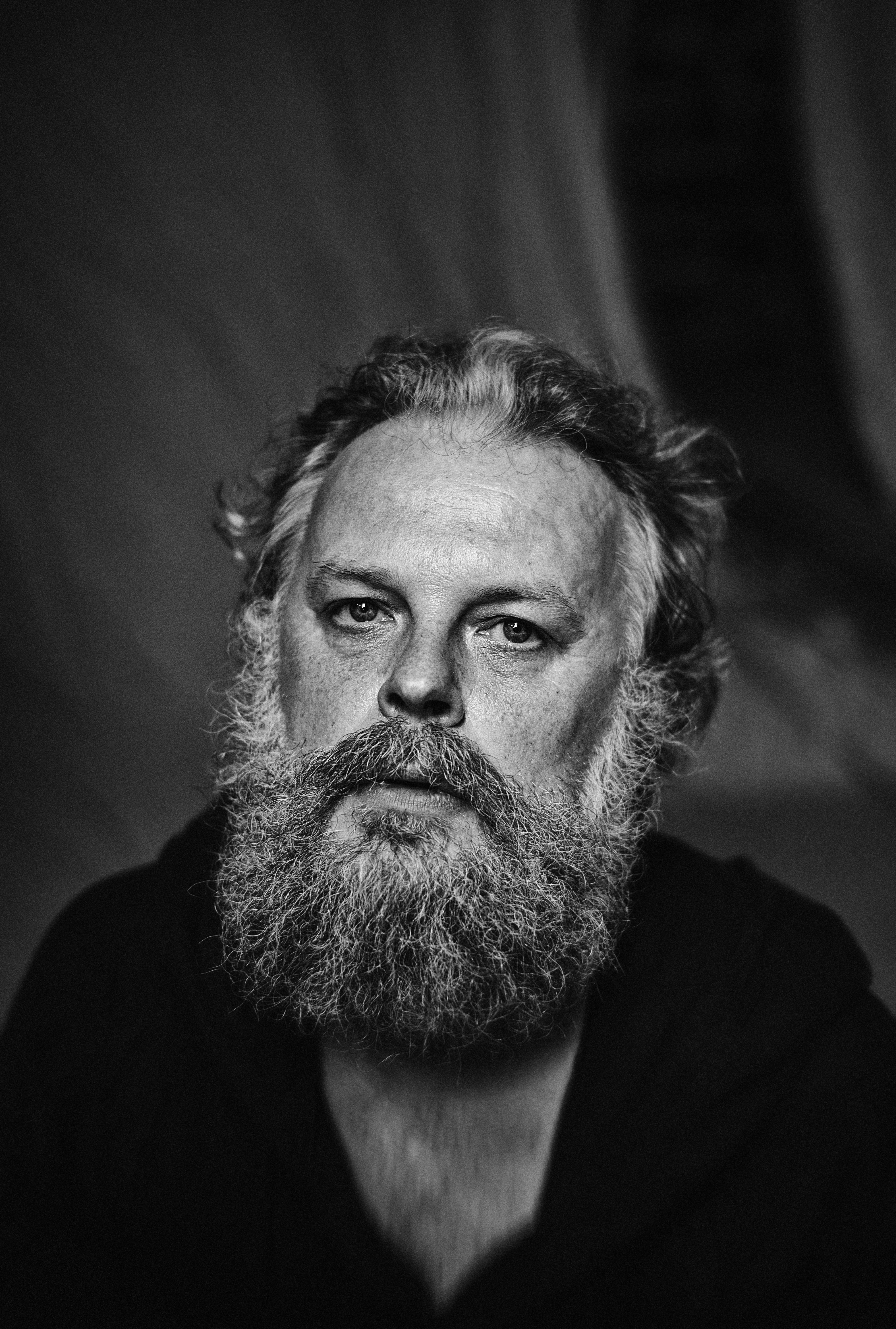 Portrait of Quiet Resolve: A Man with Weathered Beard in Monochrome