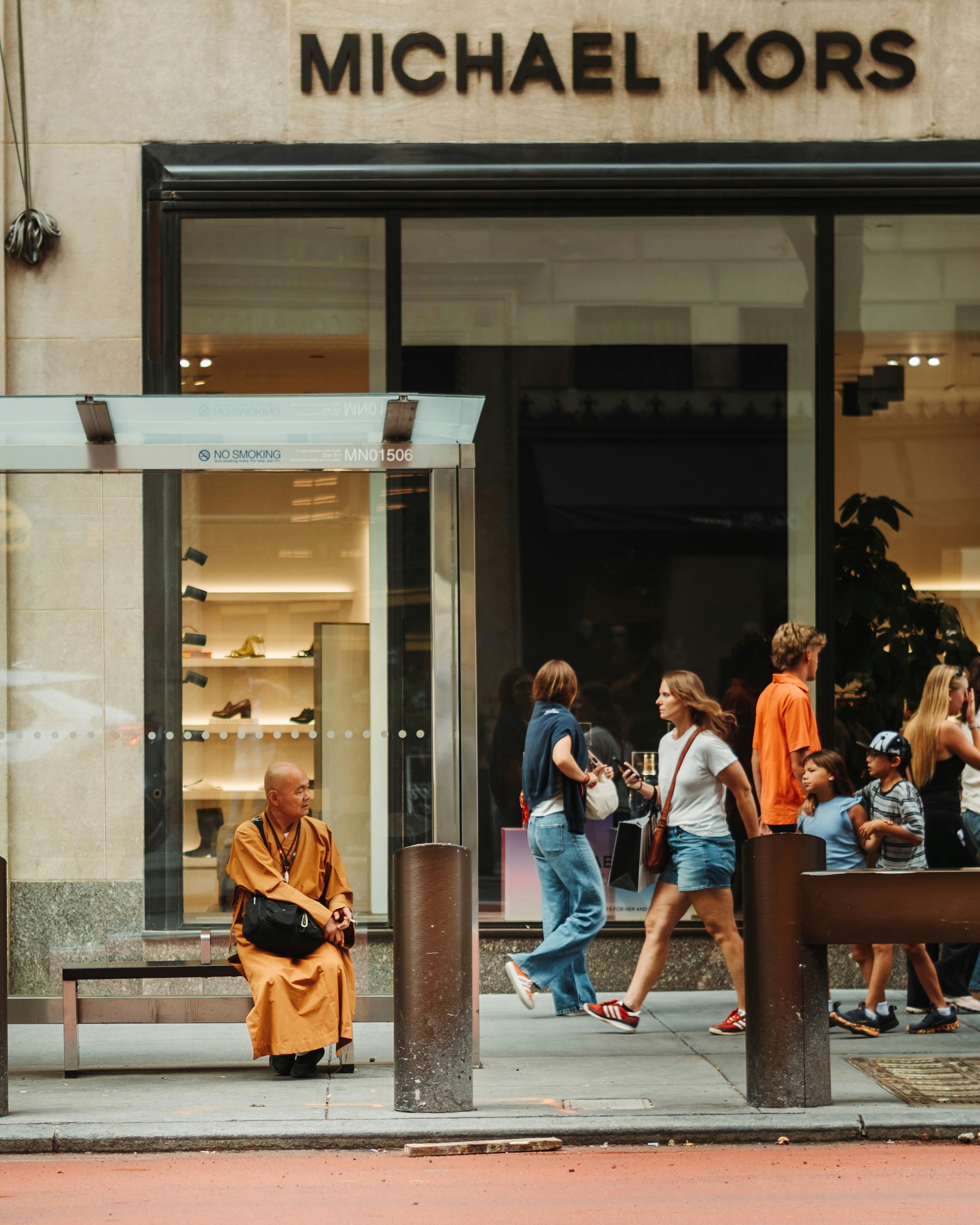 Streetwear and Solitude: A Monk on the Active Avenue