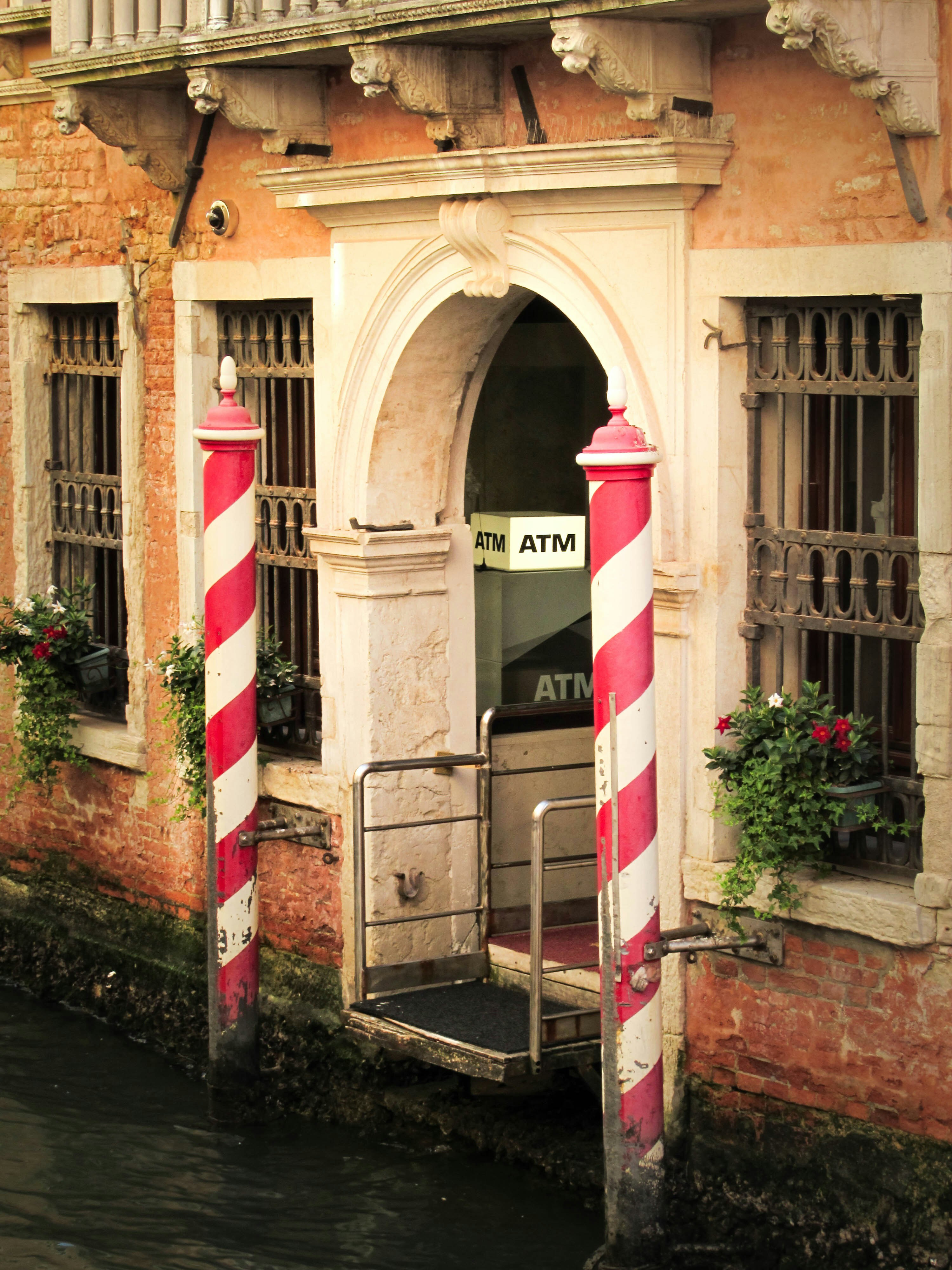 Venetian Canal Doorway framed by striped sentinels