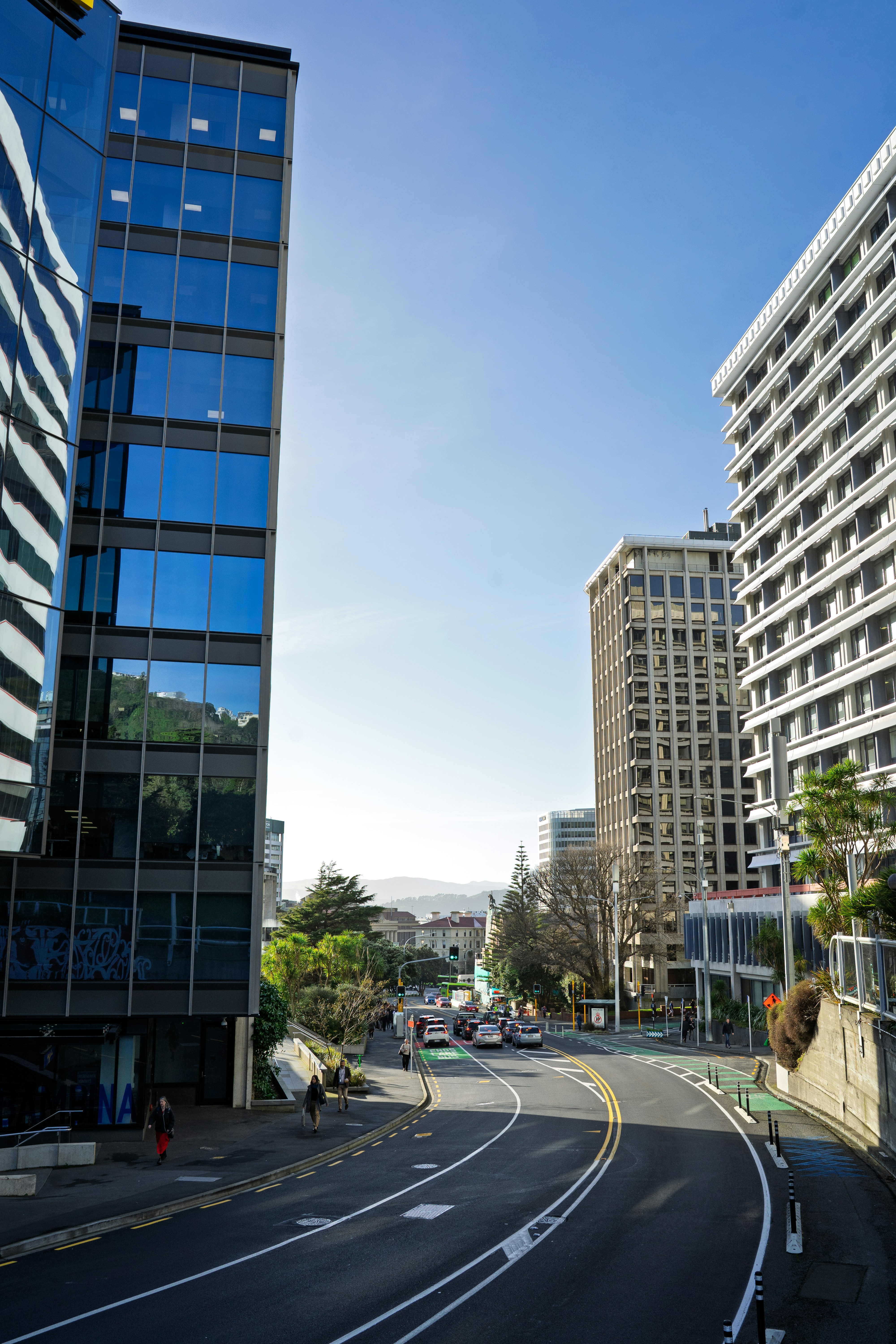 Urban Boulevard: A Clear Day Between Glass Skyscrapers