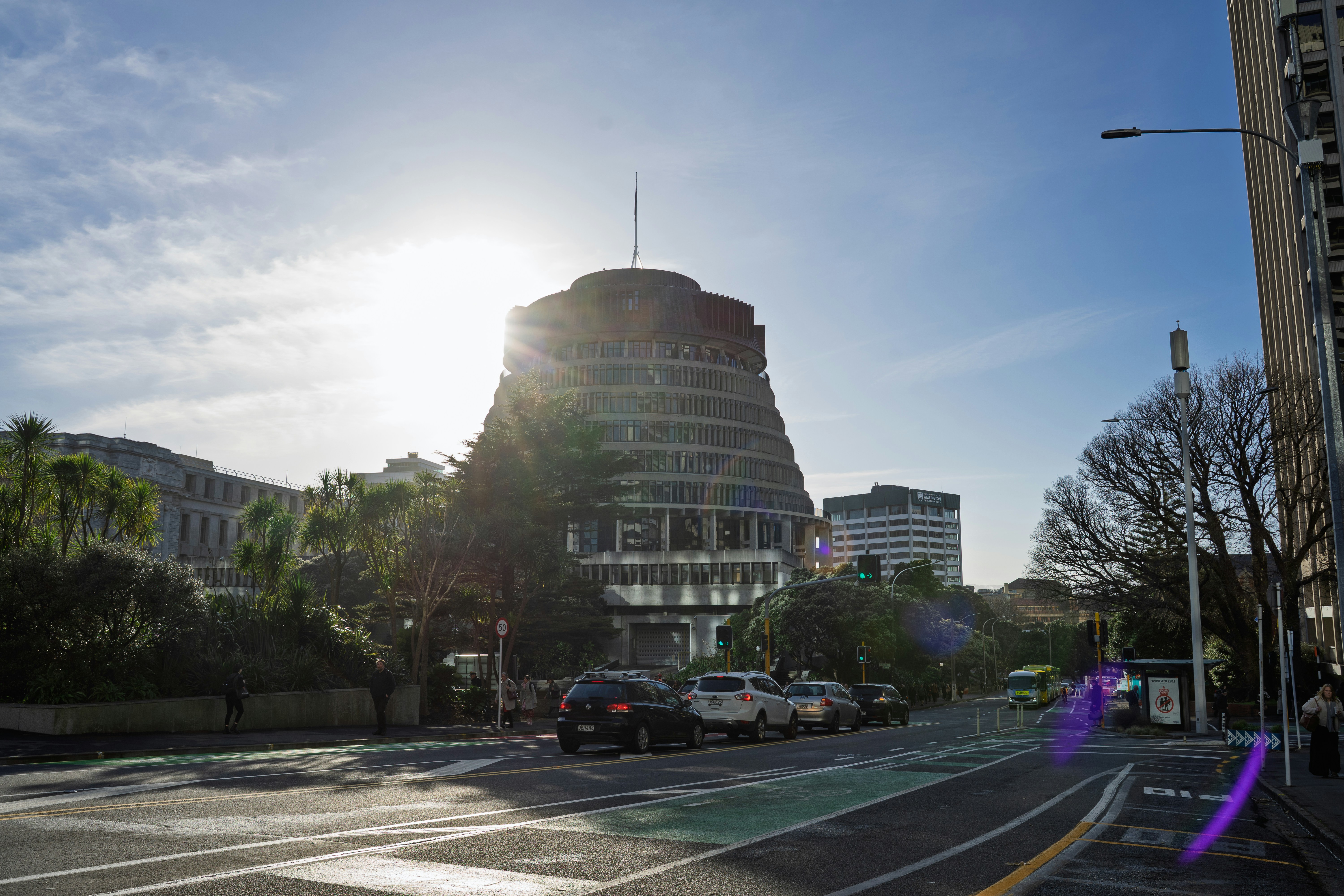 Sunlit City Roundhouse: A Modernist Landmark Framed by Morning Traffic