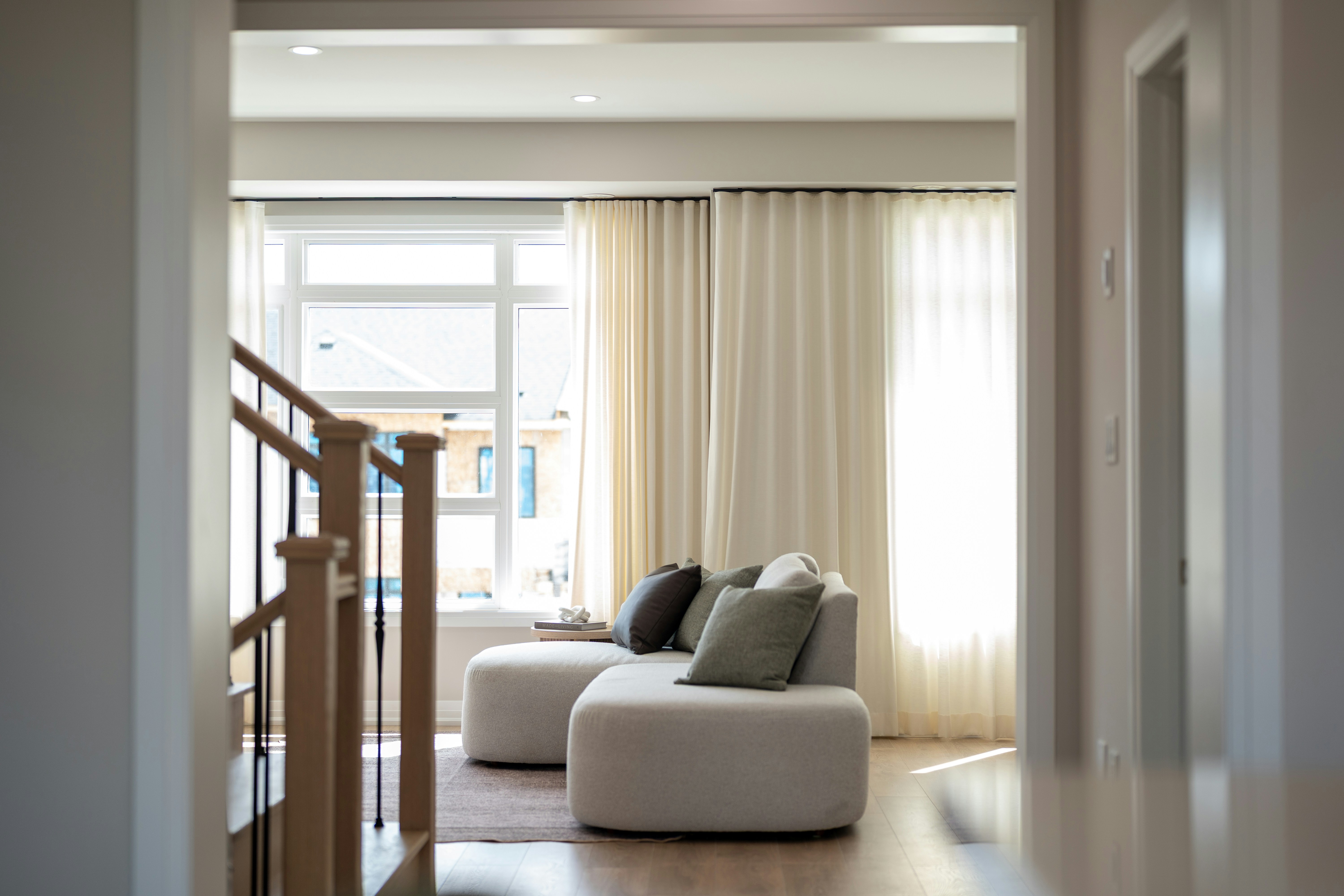 Soft-light Oasis: Minimalist Living Room with Curved Modular Sofa