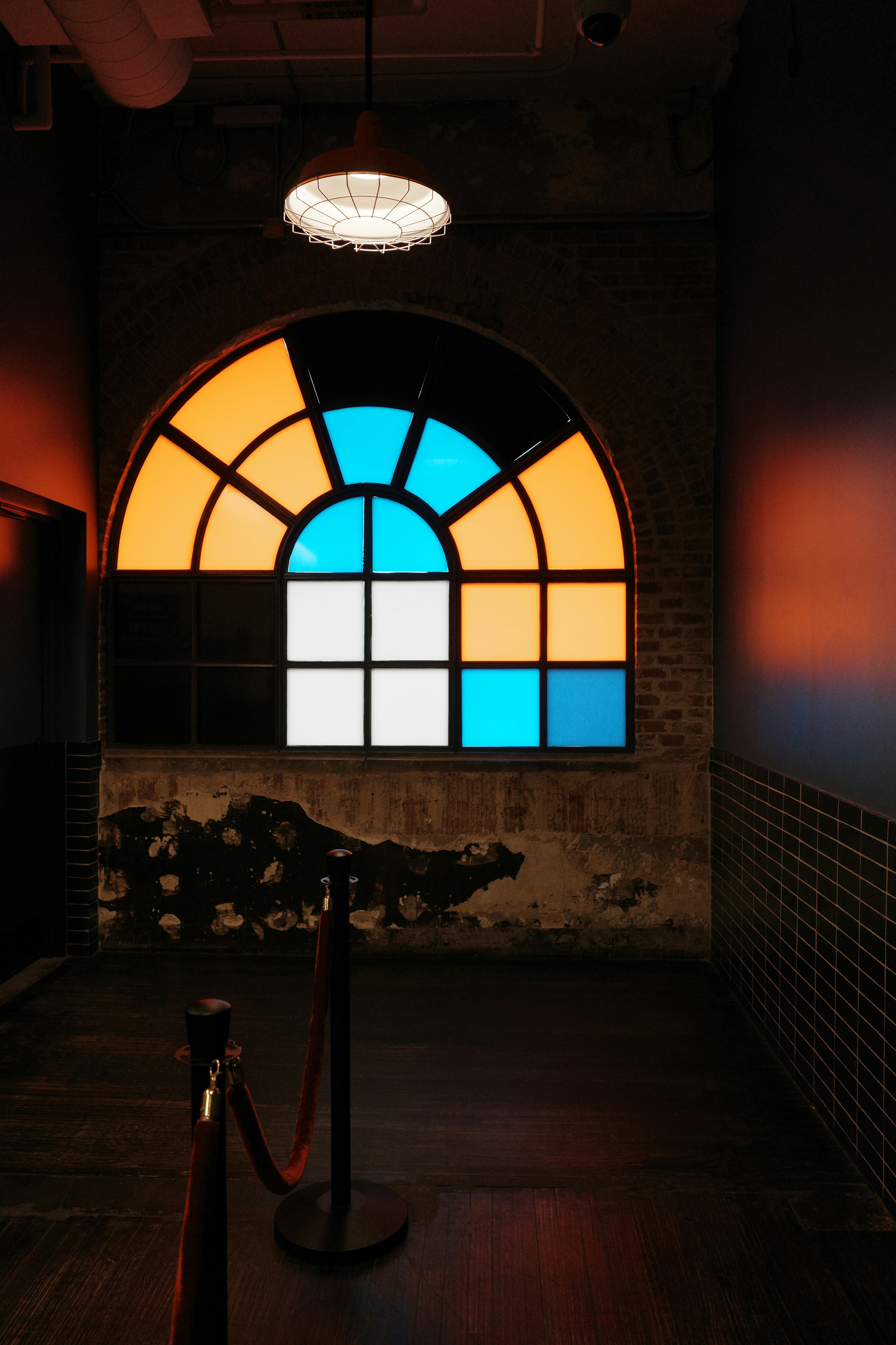 Stained Window Glow in an Industrial Corridor