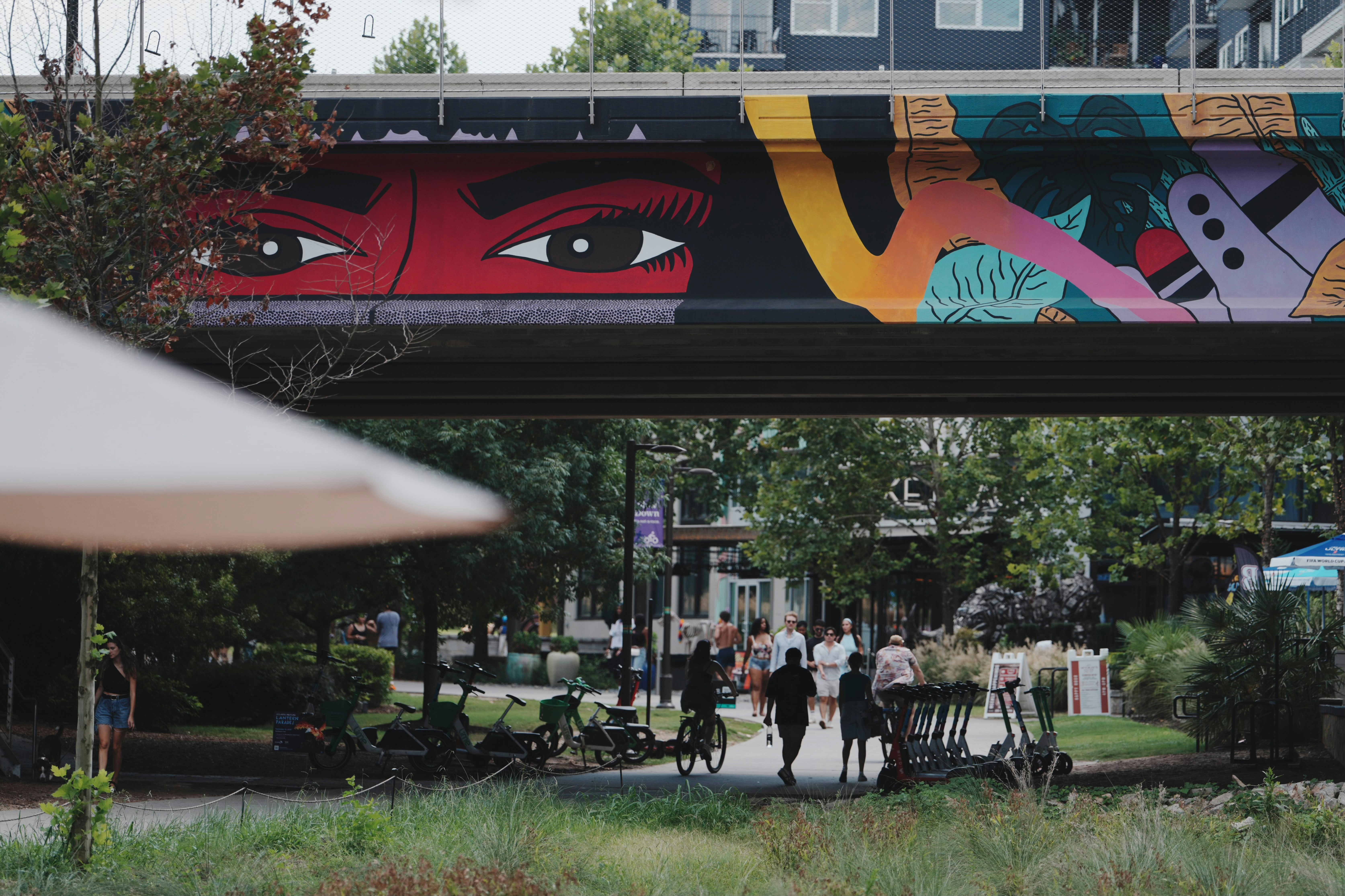 Urban mural underpass: pedestrians framed by vibrant graffiti