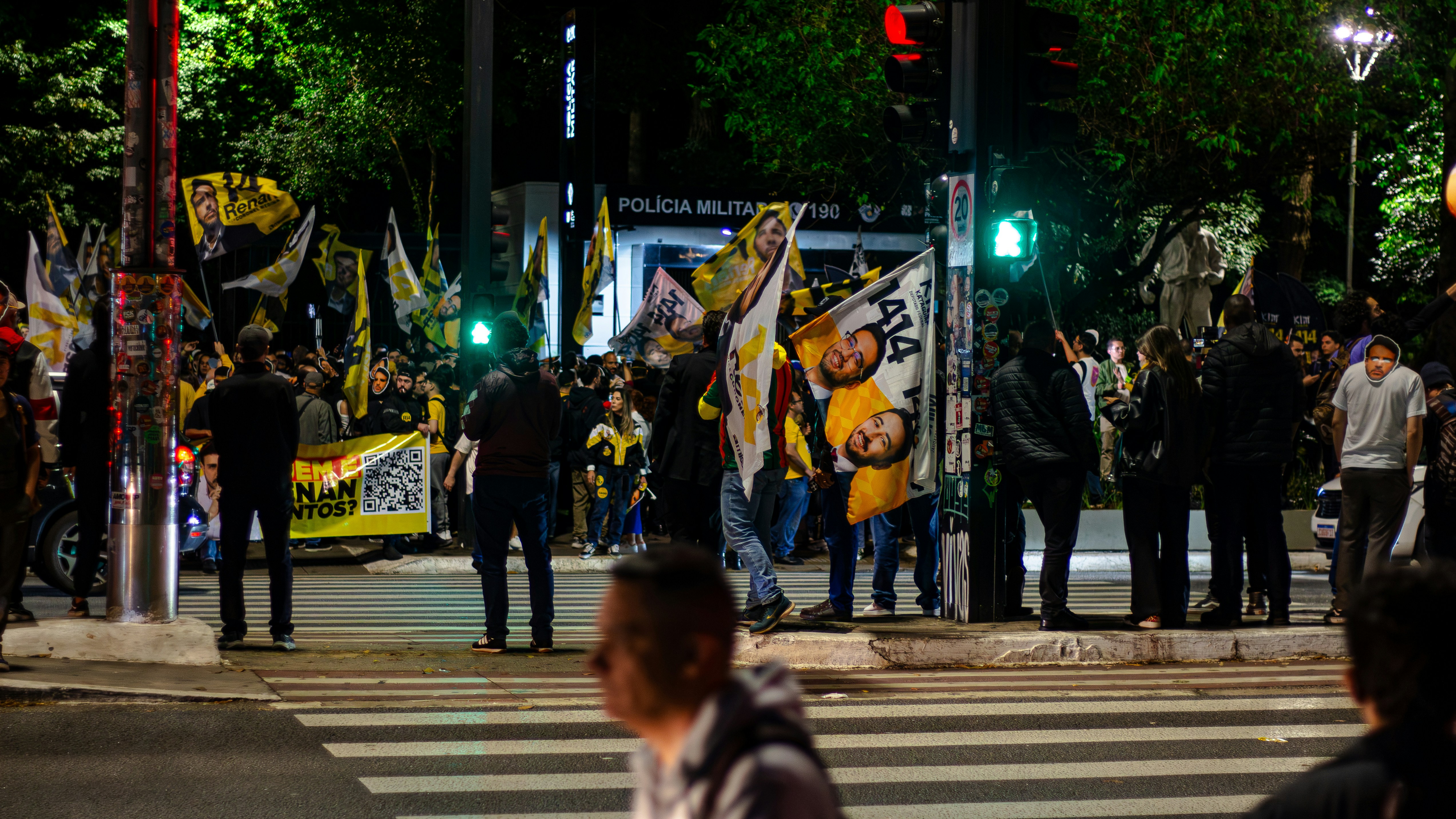 Night Parade: Flags and Bannered Assembly Under Green Streetlights