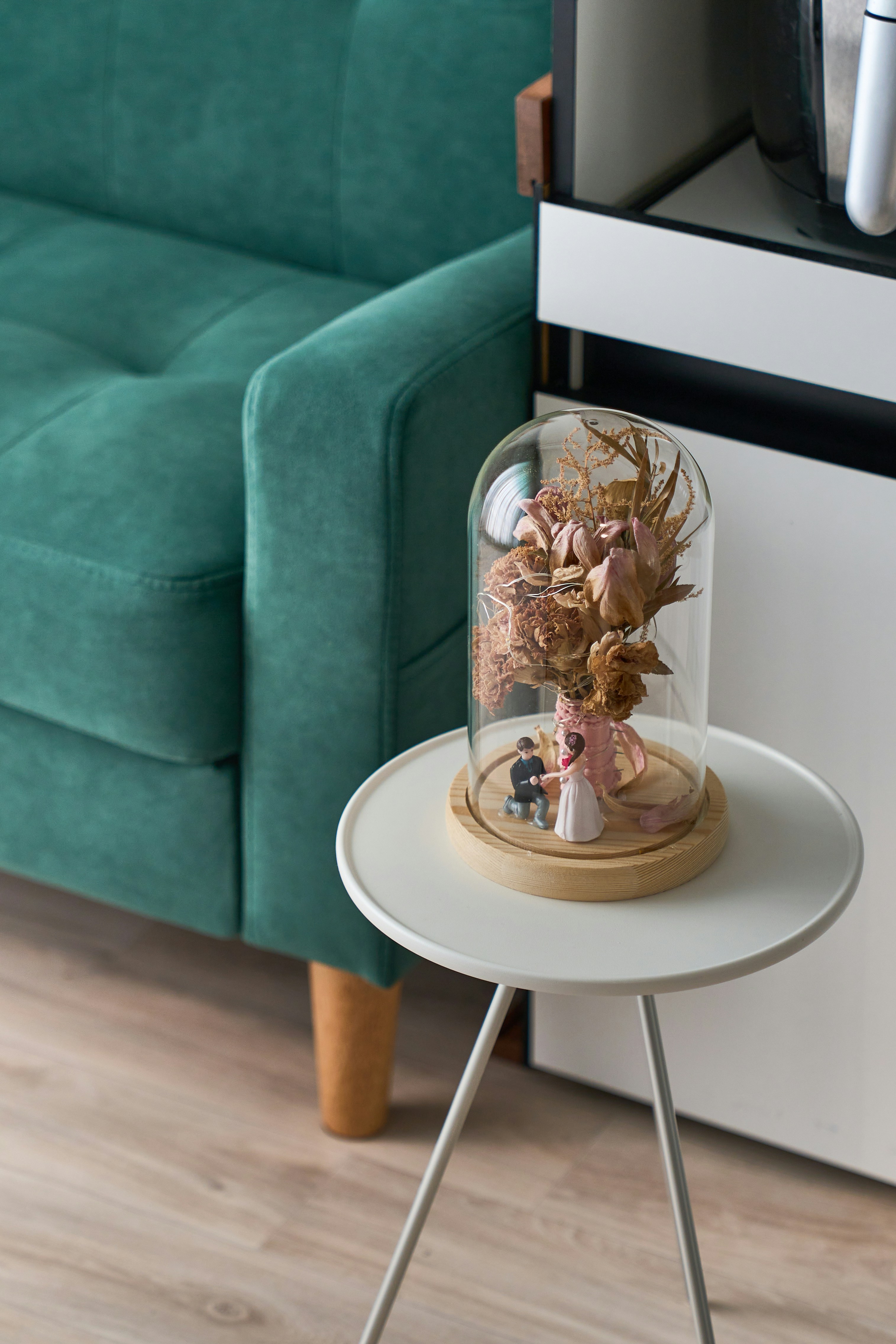 Glass Dome of Miniature Moments on a White Round Table