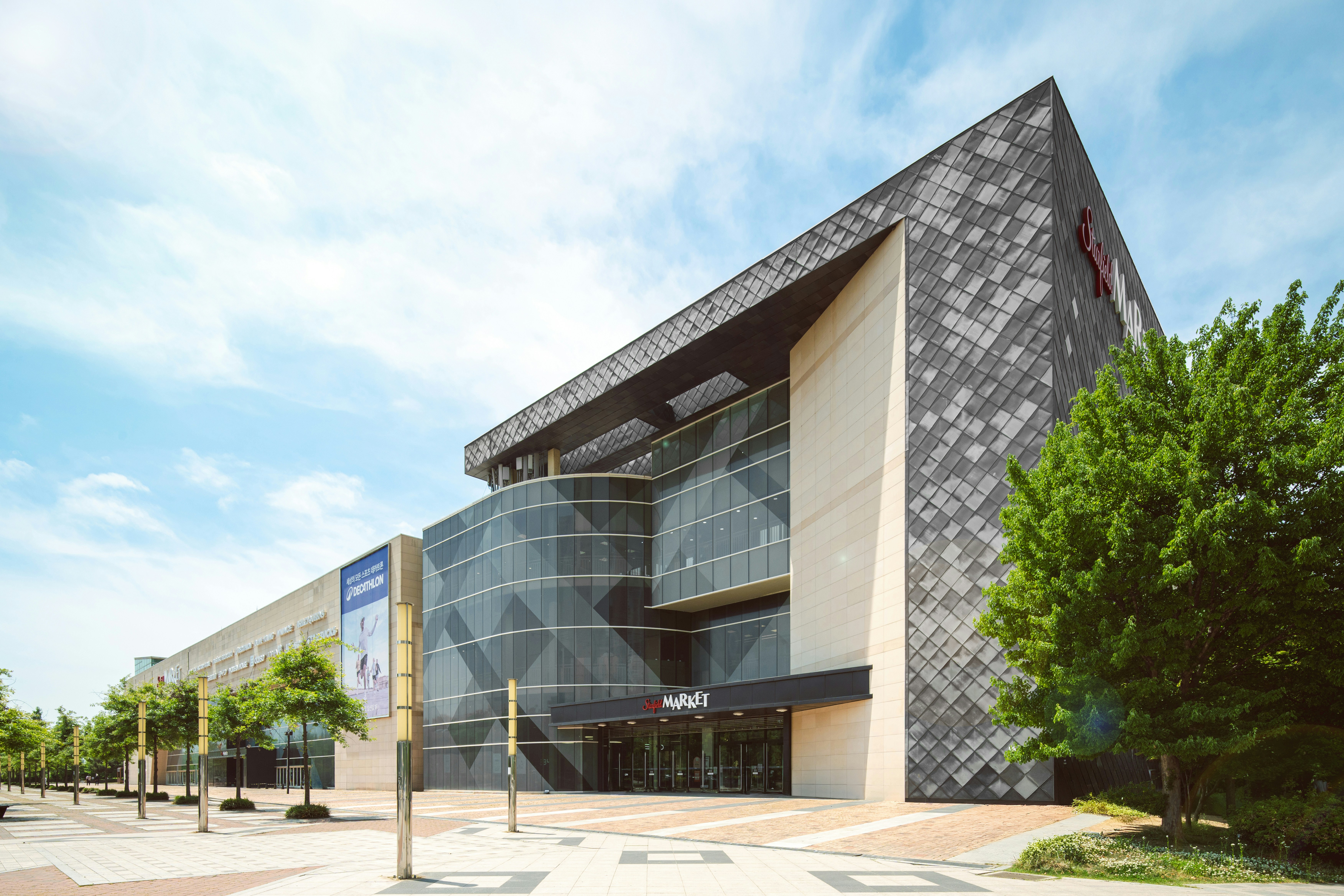 Angular Facade, Shaped Glass, and Sunlit Plaza
