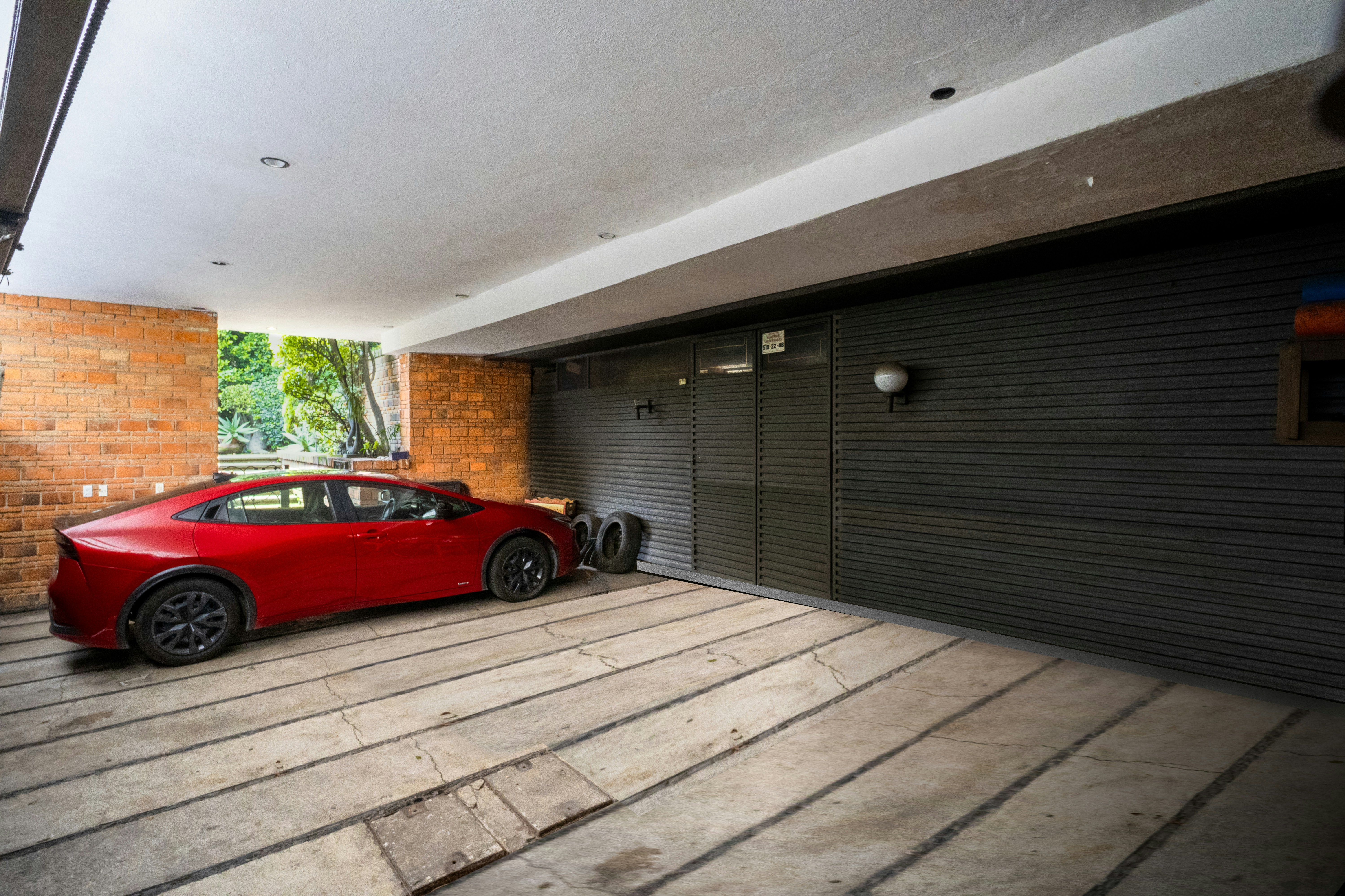 Red Compact Car in a Minimalist Garage