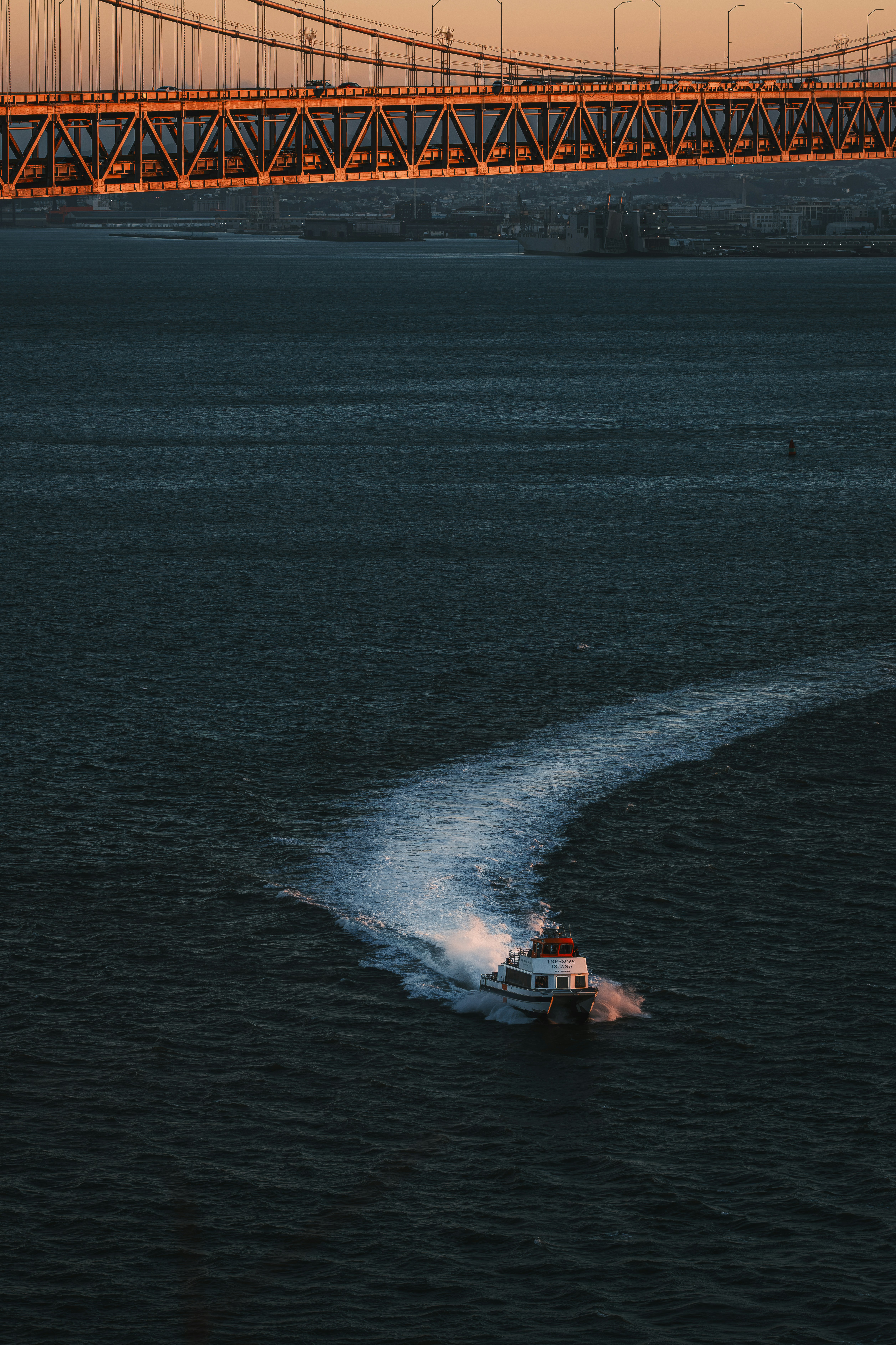 Rushing Harbor: Boat Skims beneath an Amber Bridge