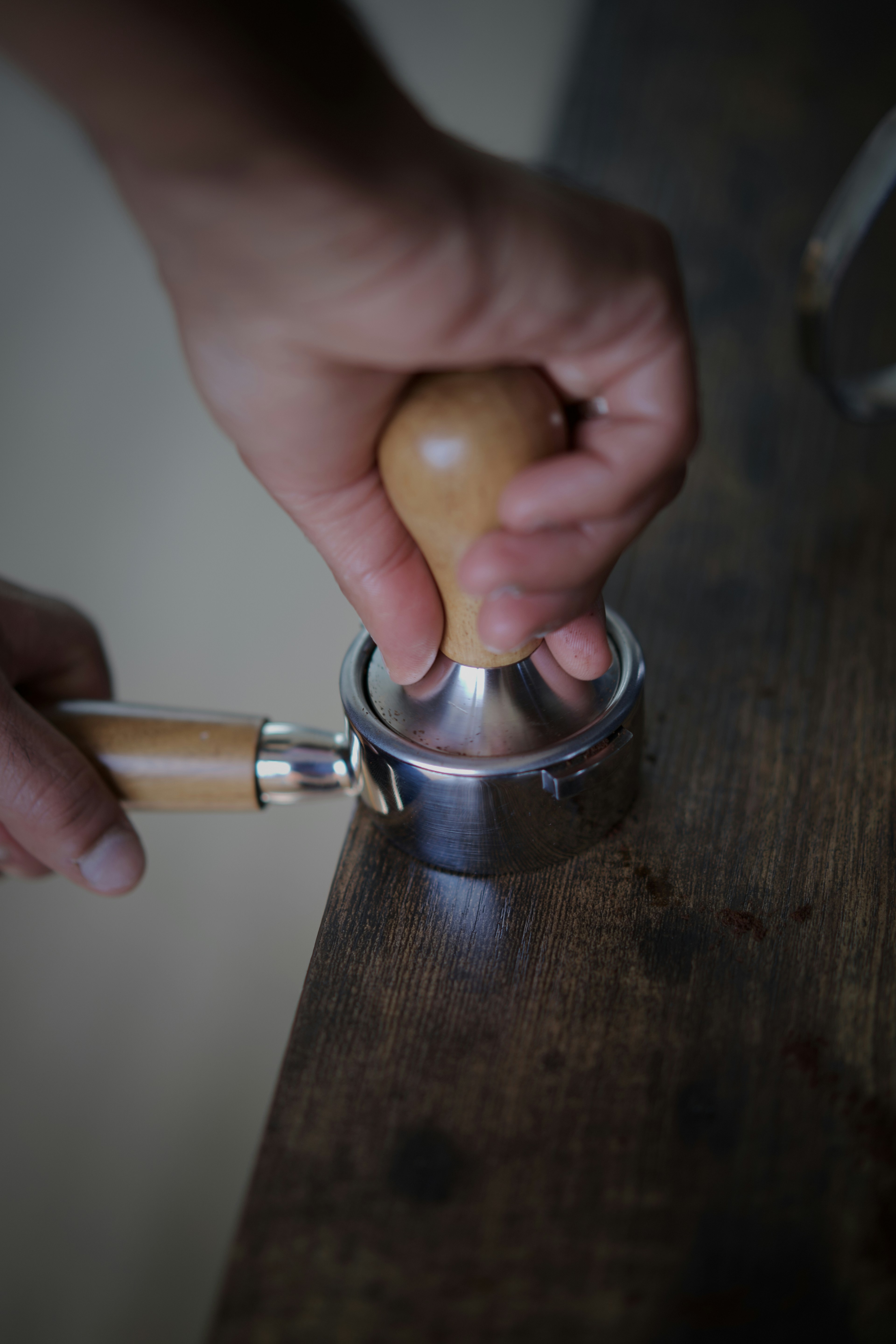 Hands at Work: Espresso Cup and Mocha Pot in a Rustic Kitchen