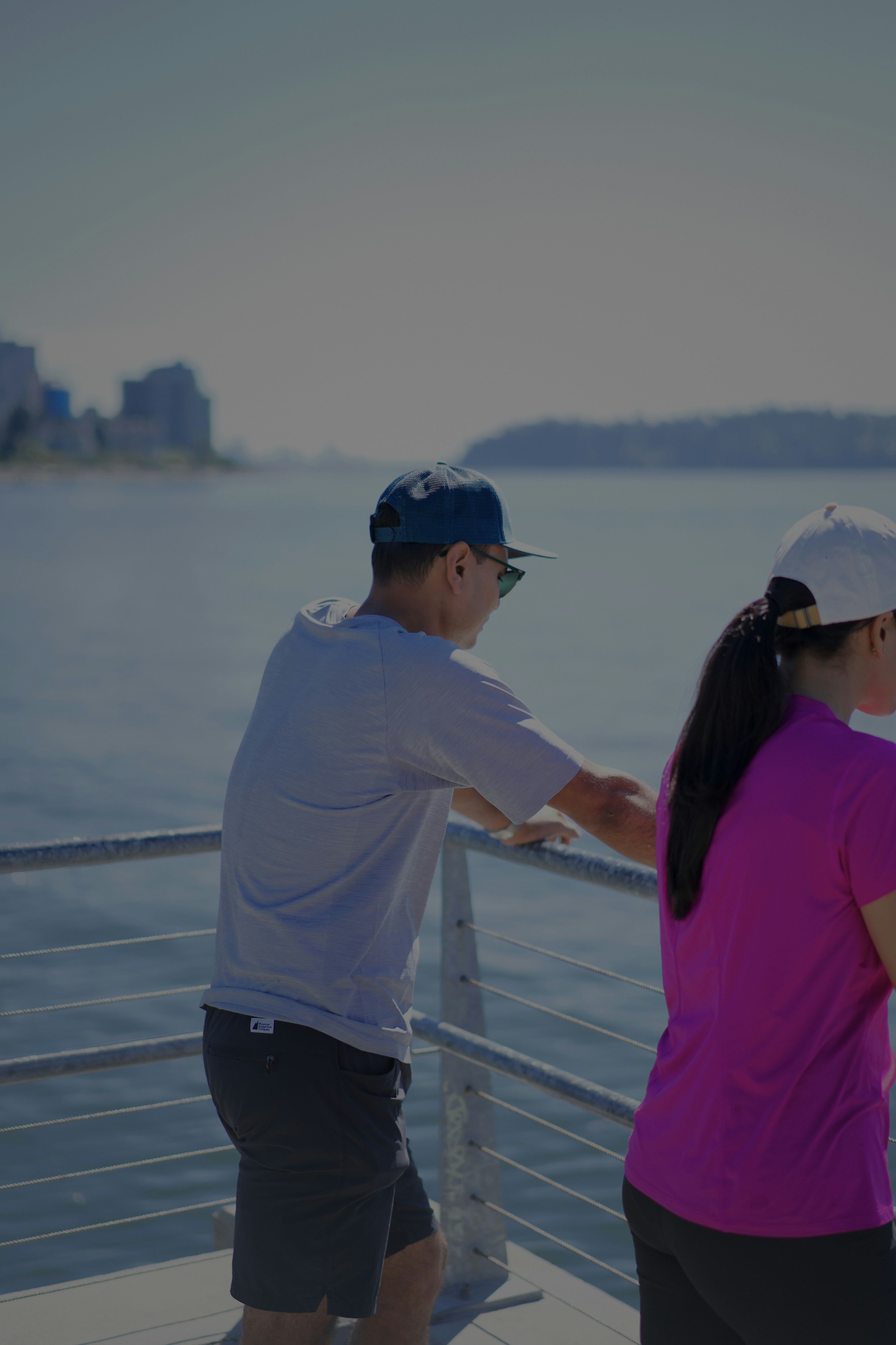 Railing Conversation: Two hikers on a waterfront overlook