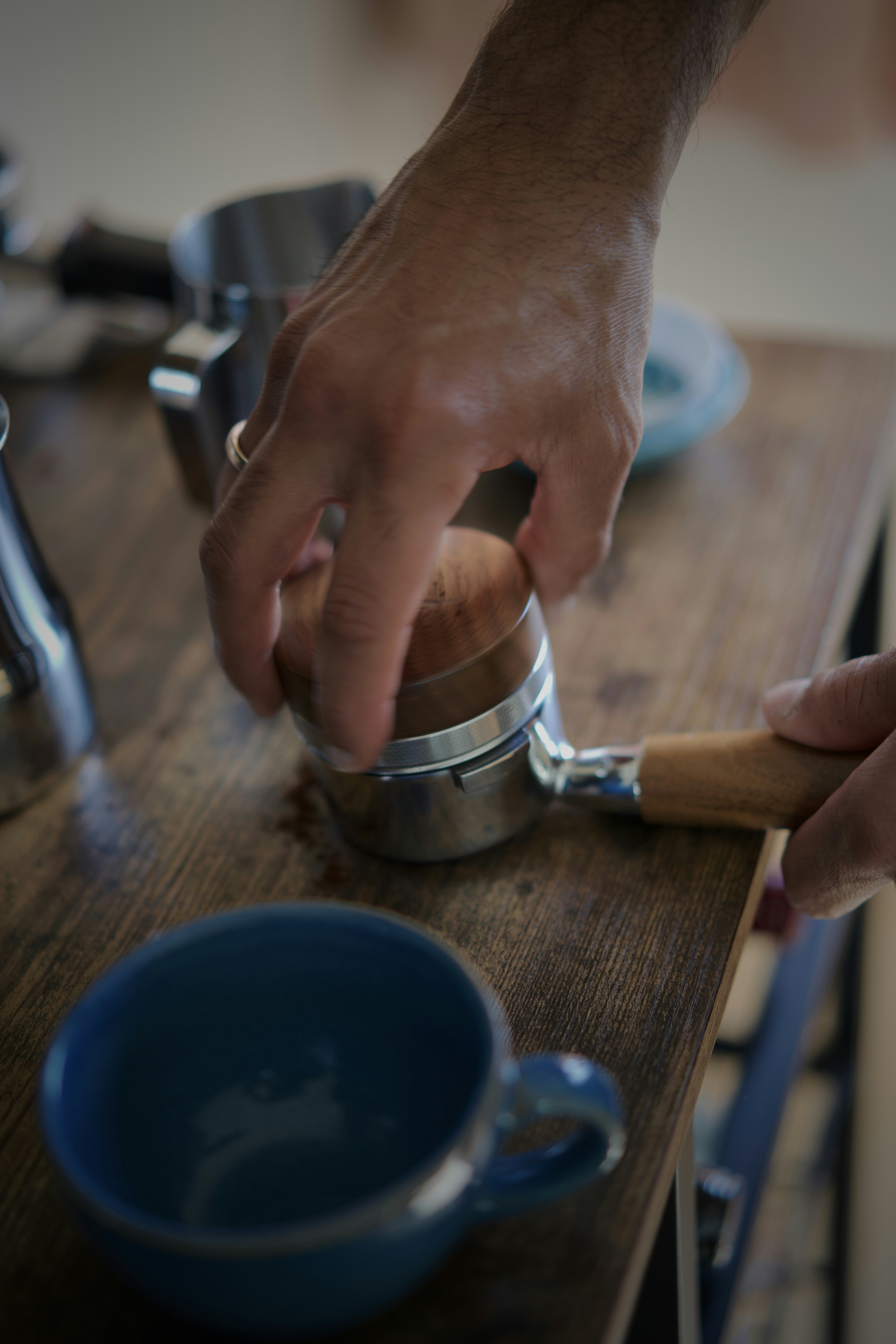 Hands at Work: A Barista’s Precision with a Porter and Cup