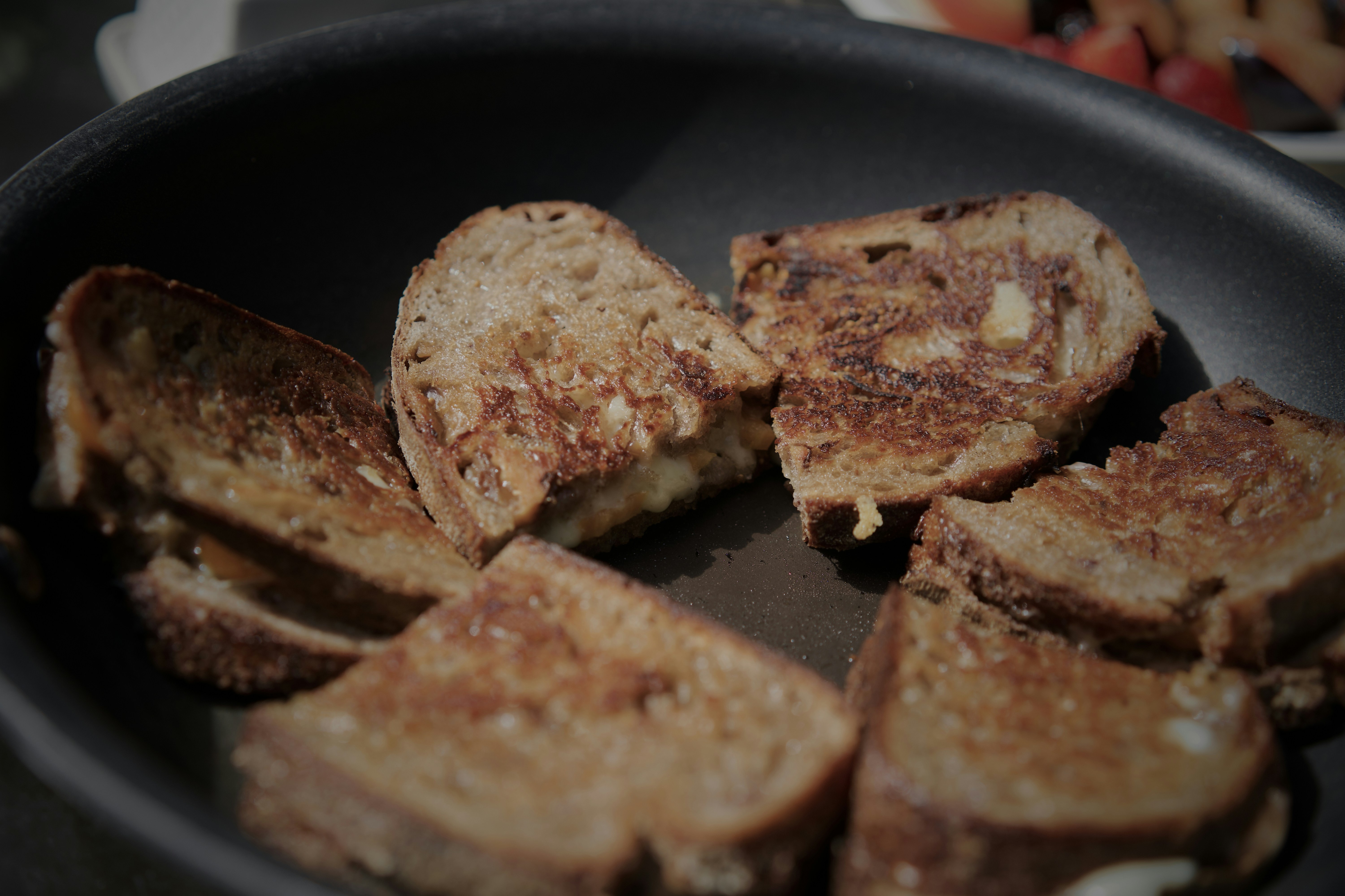 Golden-Brown Toast Chunks Sizzling in a Frying Pan