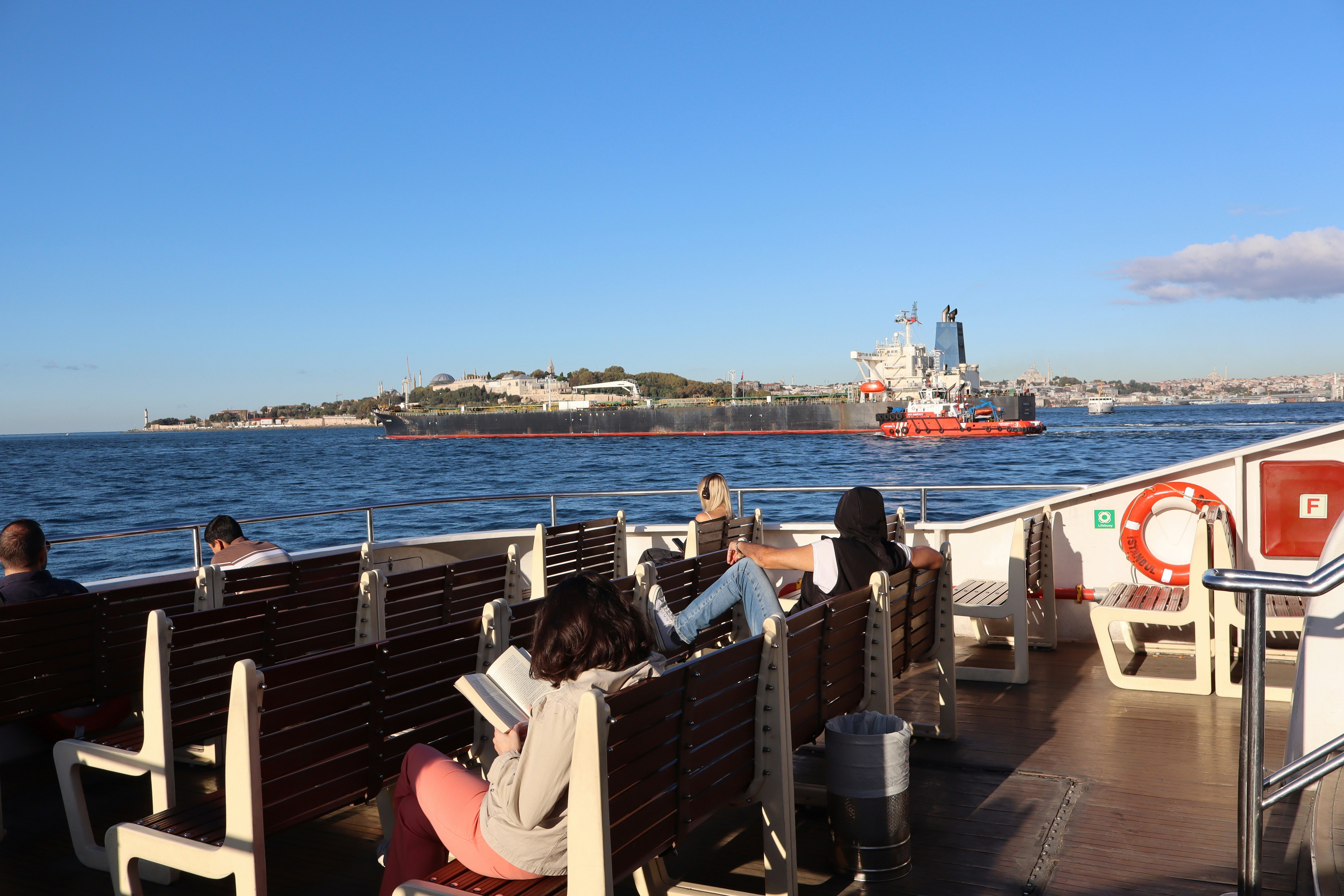 Seating Aboard the Harbor Deck with a Distant Seaport Tug