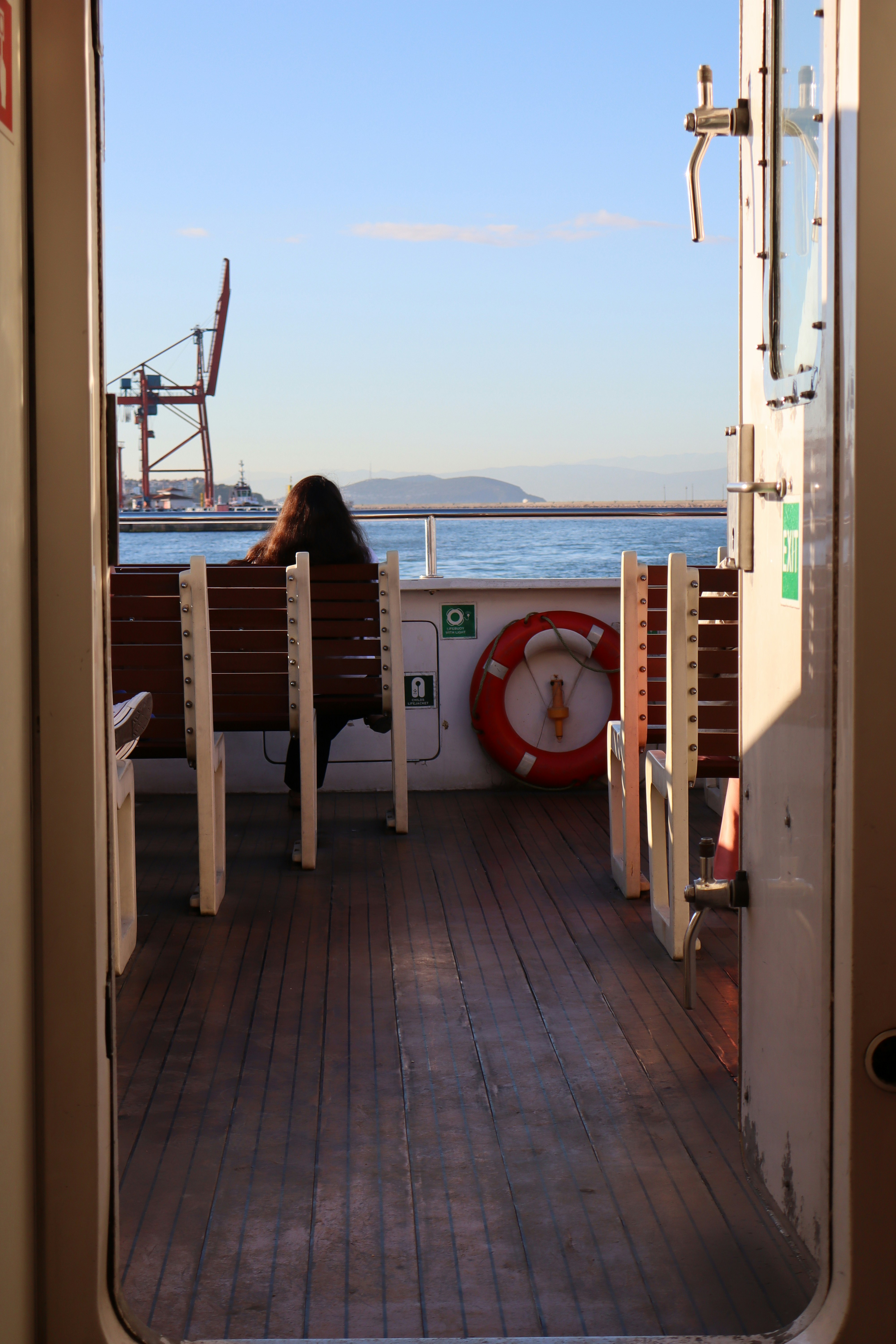 Window to the Harbor: Deck Chairs Framed by an Open Door