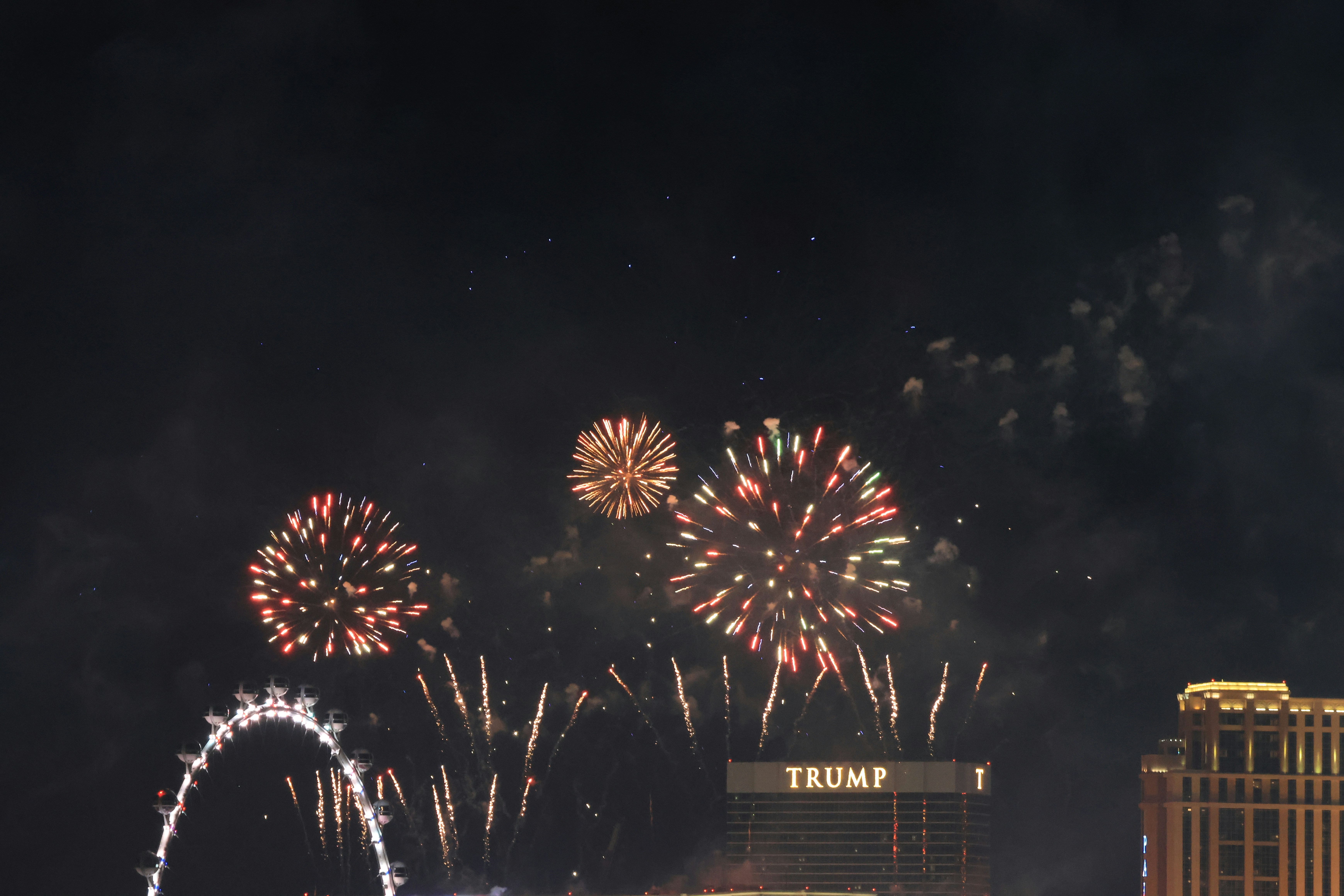 City Lights, Night Sky, and Bursting Fireworks Over the Skyline